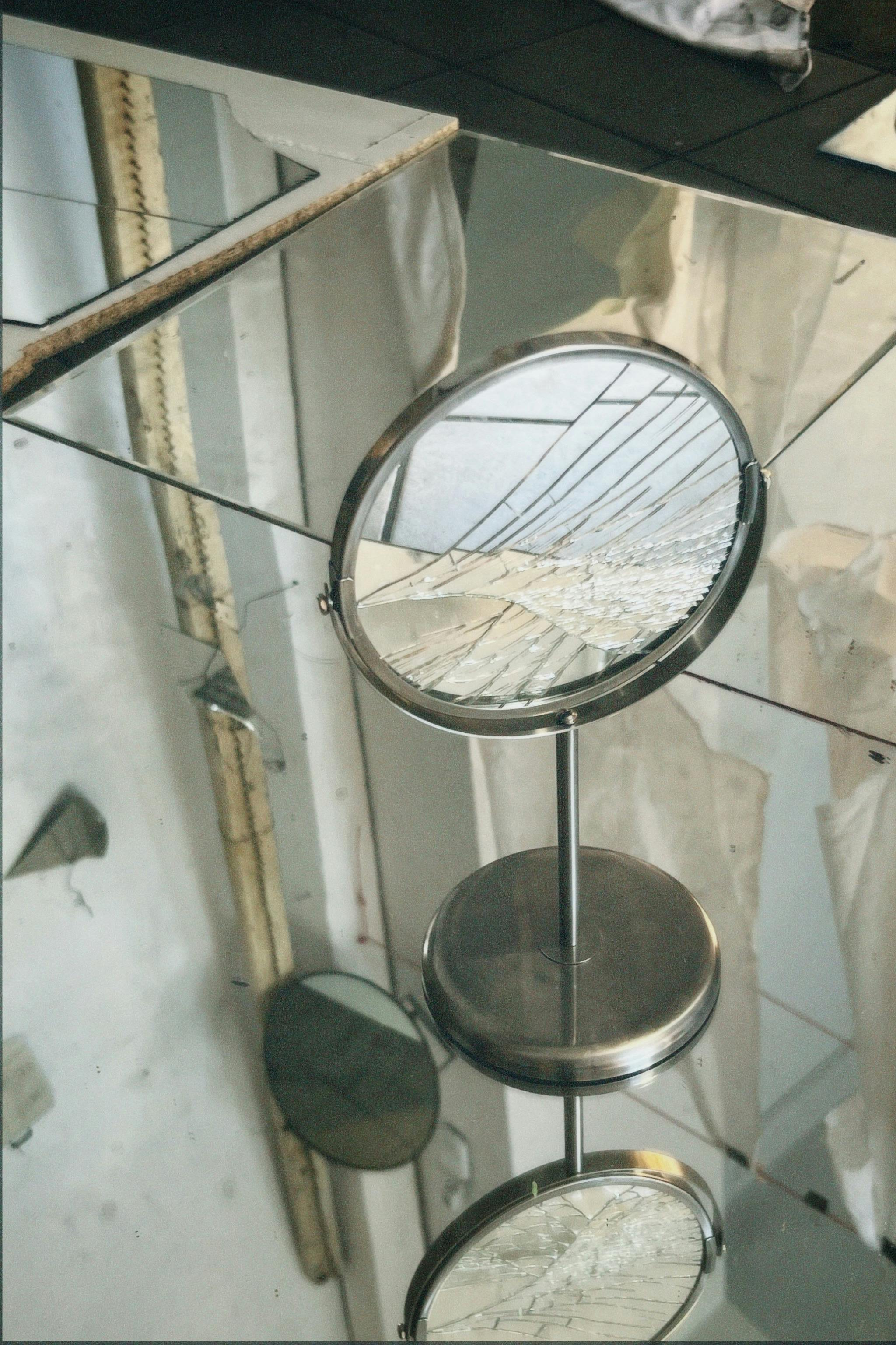 Mirror Fragments on Gray Surface With The Reflection Of A Person's Hand ...