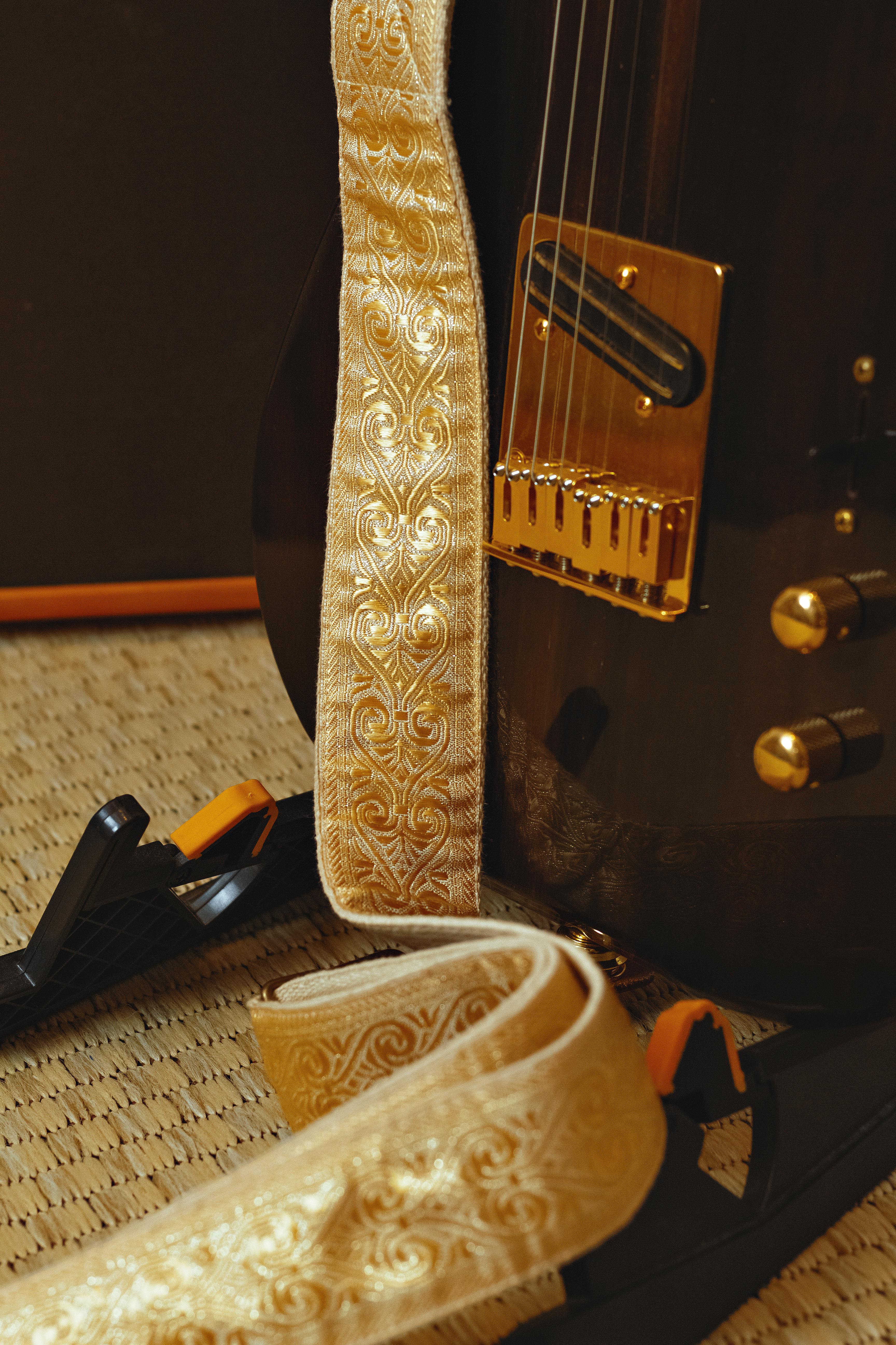 Close-up of an Electric Guitar with a Patterned Strap · Free Stock Photo