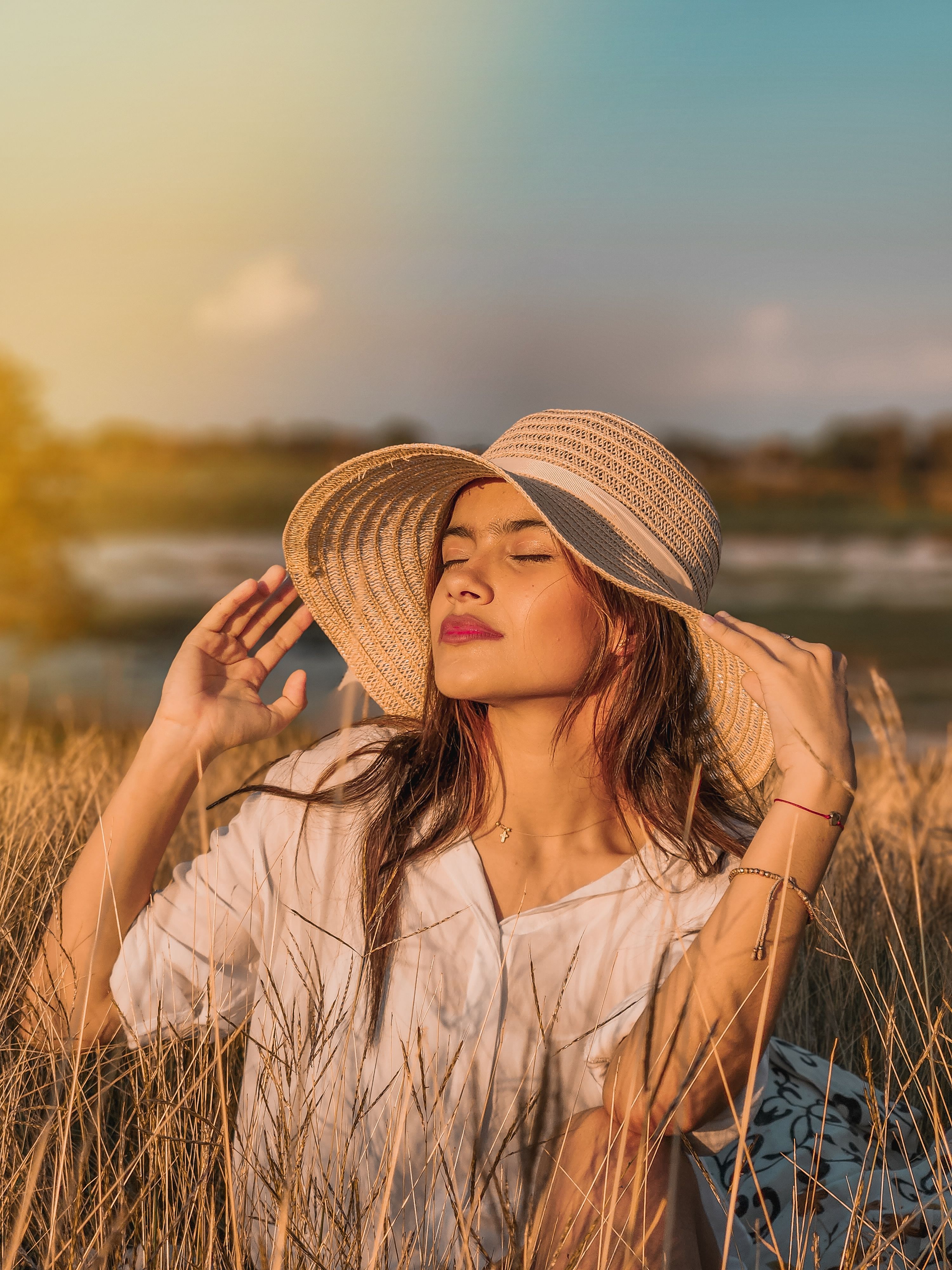 A Portrait of a Woman Wearing Hat in Sunlight · Free Stock Photo