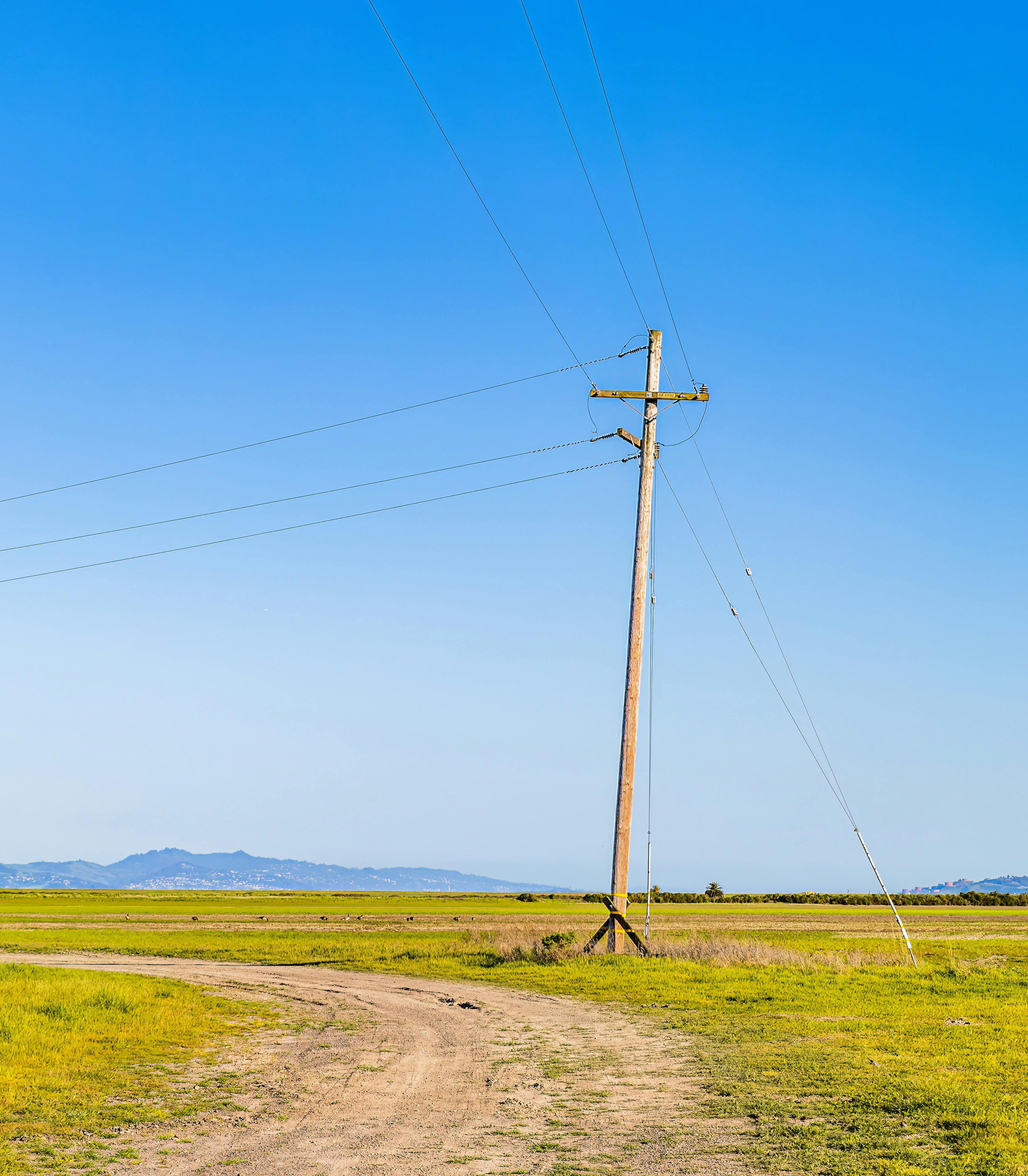 A Voltage Pole on the Field · Free Stock Photo