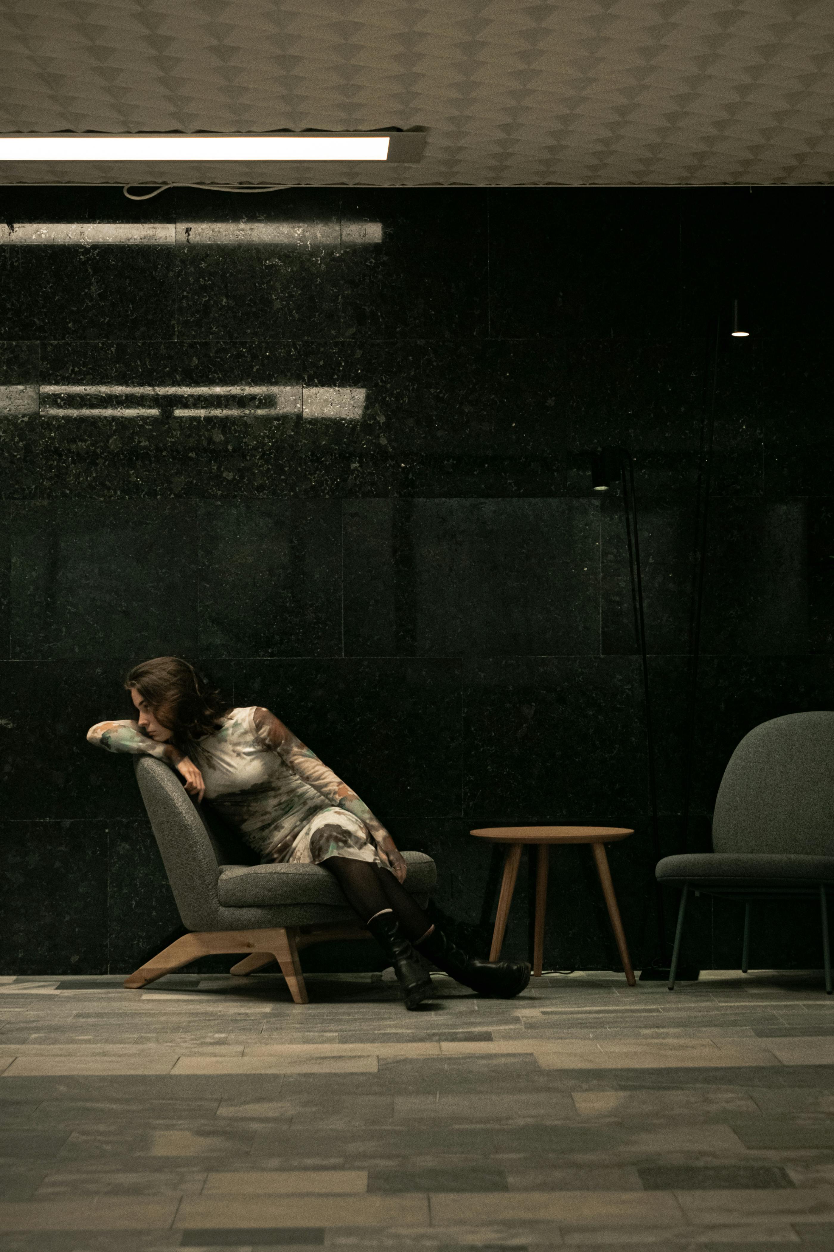 Woman Sitting on Chair Indoors · Free Stock Photo