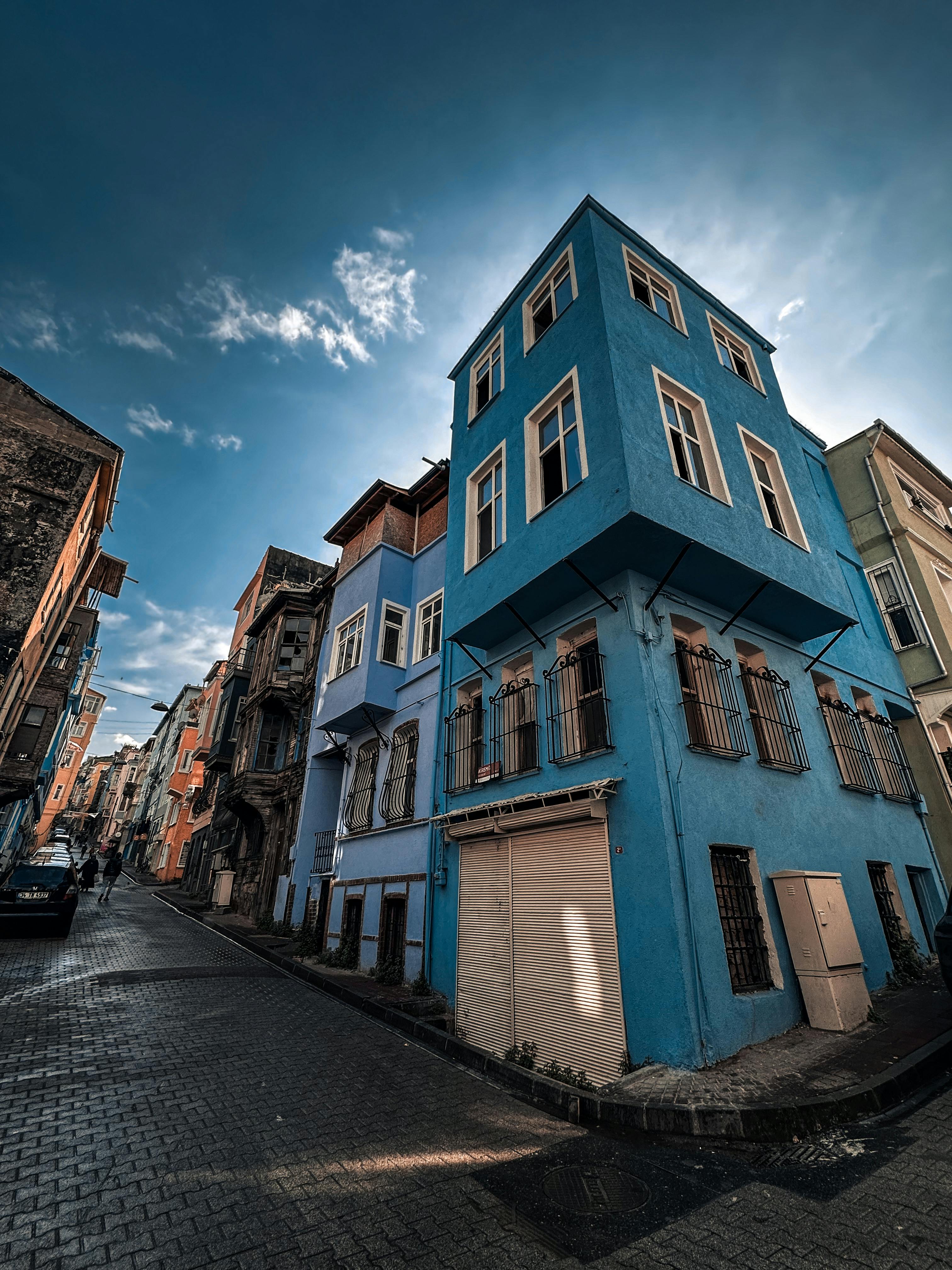 Wide Angle Shot of a Blue Residential Building on the Corner of a ...