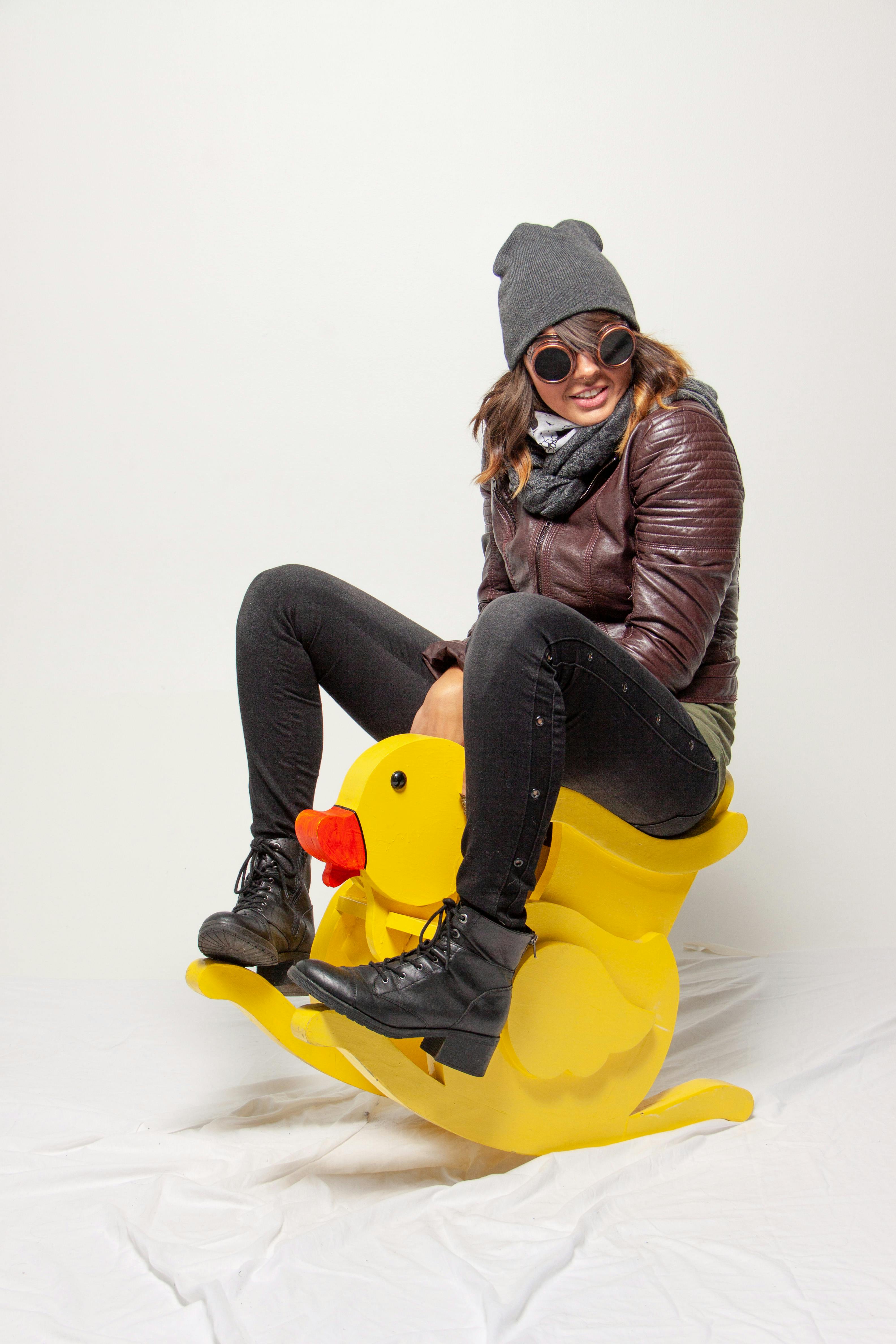 Woman Riding On Yellow Ride On Toy · Free Stock Photo