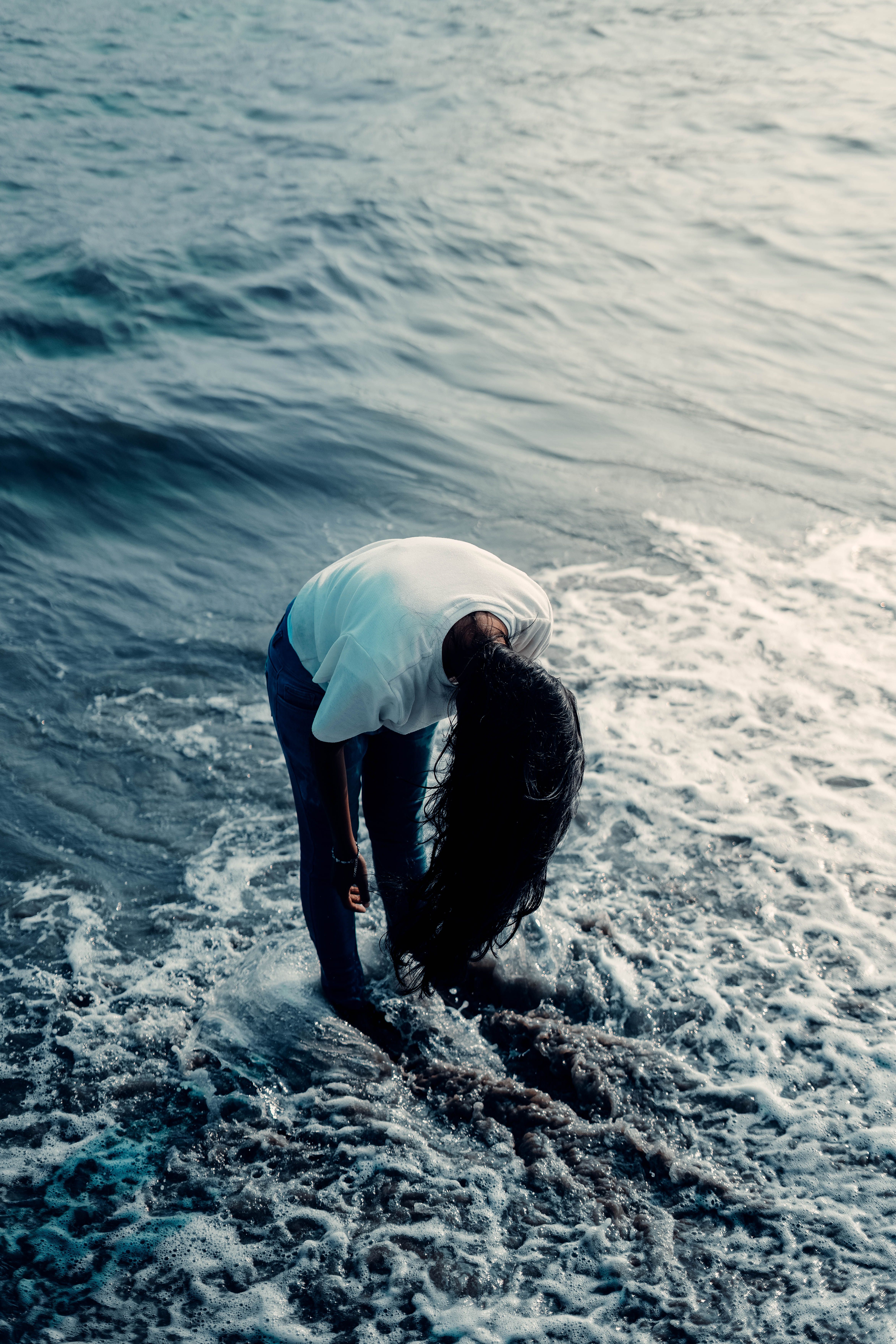 Woman Among Waves in a Sea · Free Stock Photo