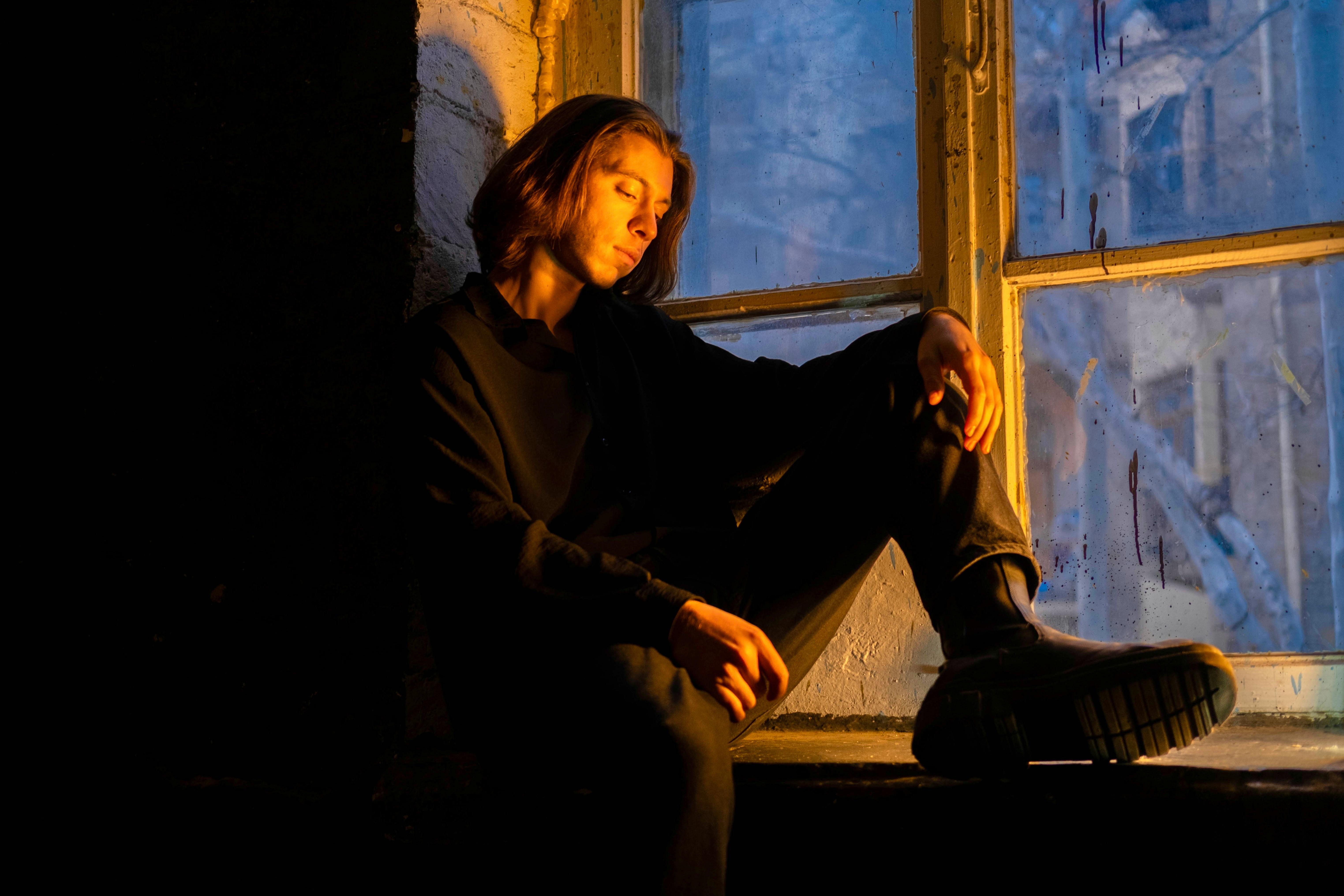 Man Sitting and Posing on Windowsill · Free Stock Photo