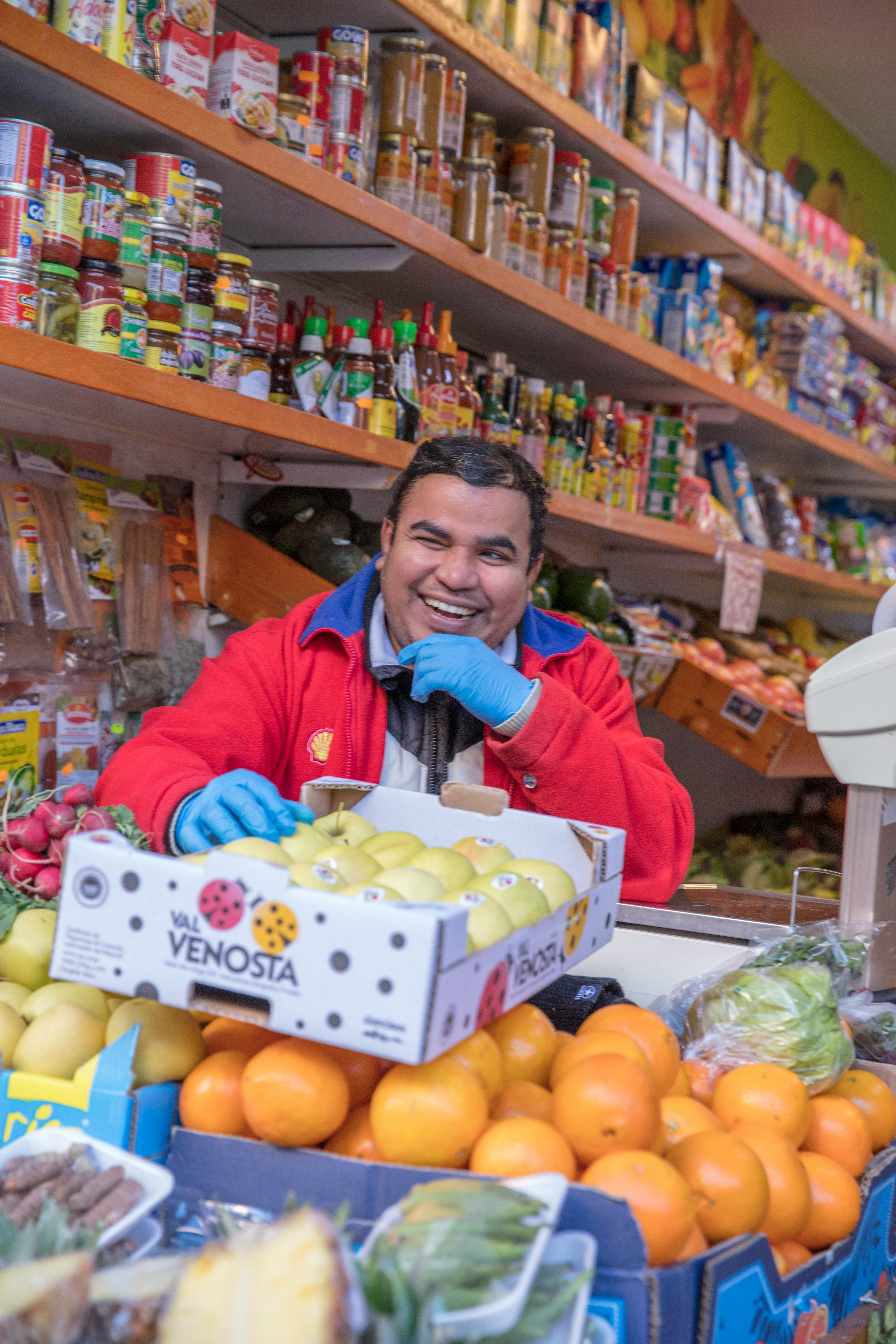 Cheerful Man Working in Grocery Store · Free Stock Photo