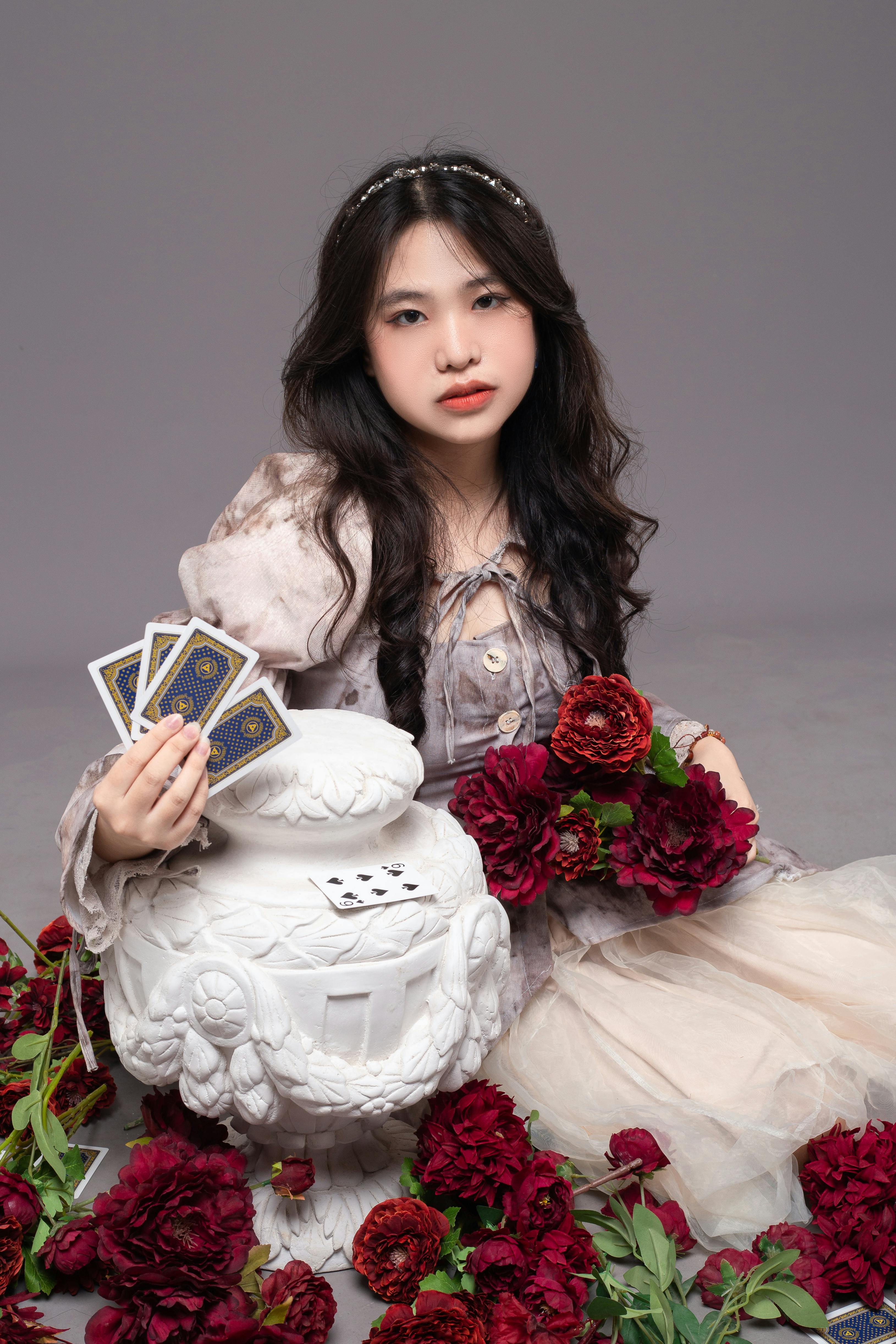 Model in Princess Dress with Flowers and Playing Cards · Free Stock Photo