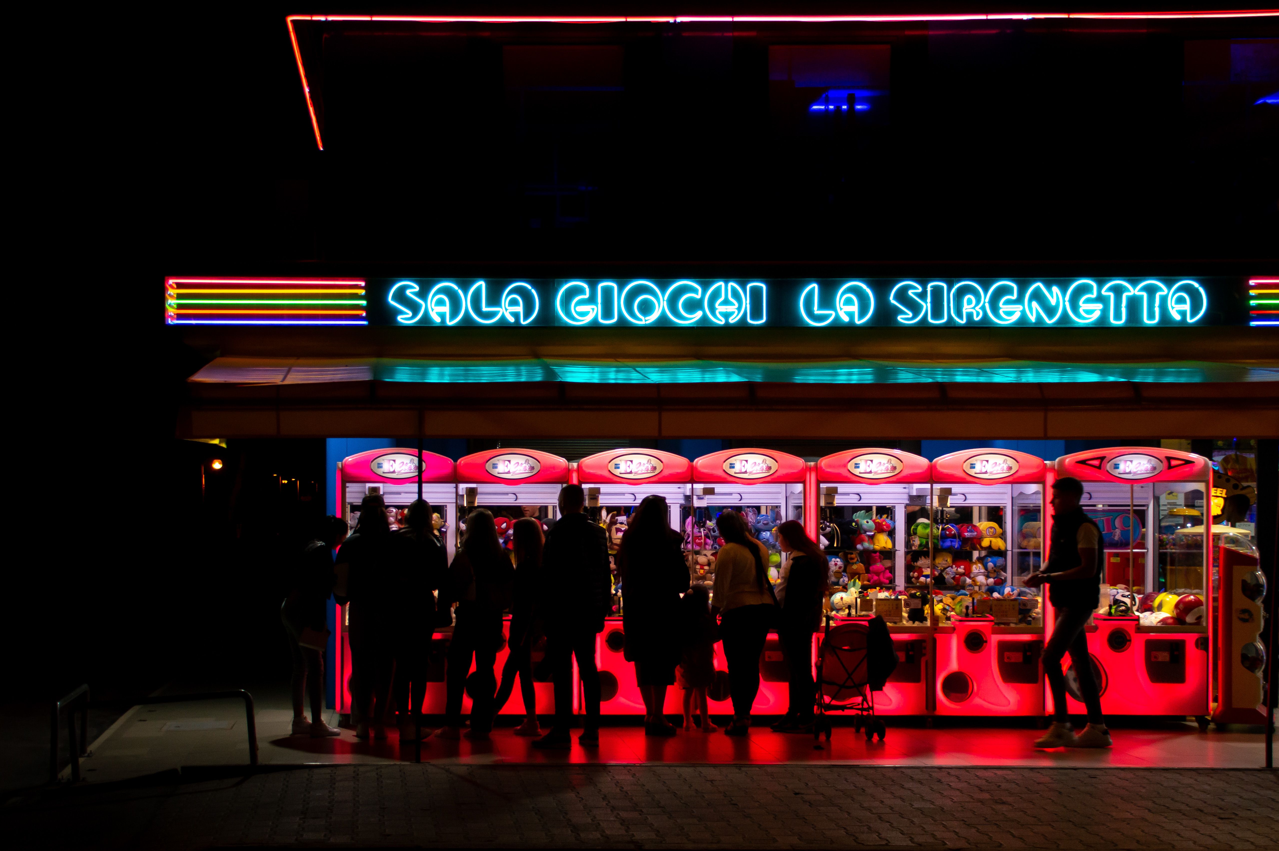 People Standing by Arcade Games at Night · Free Stock Photo
