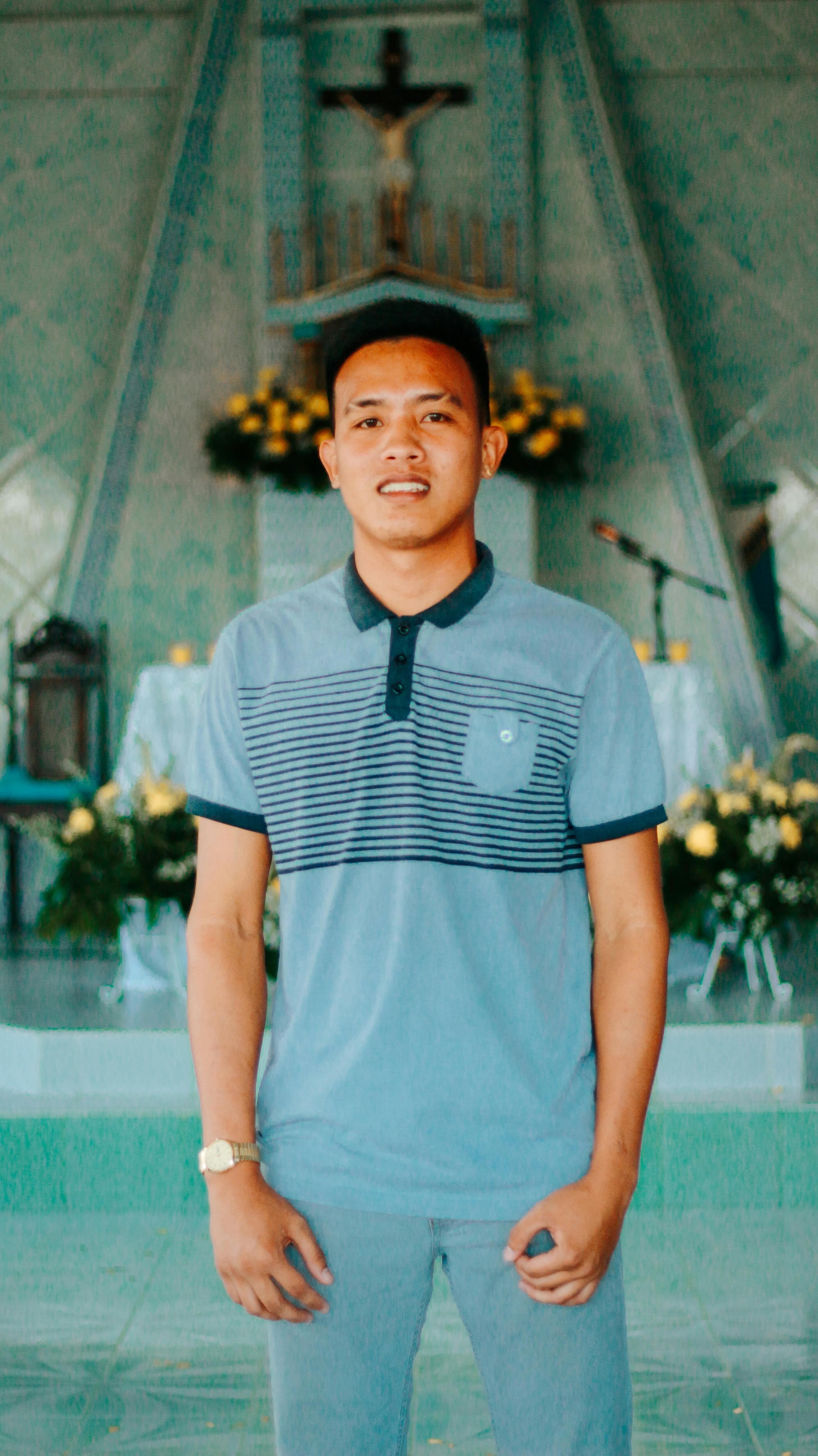Young Man in Casual Clothes Standing in front of the Altar in a Church ...