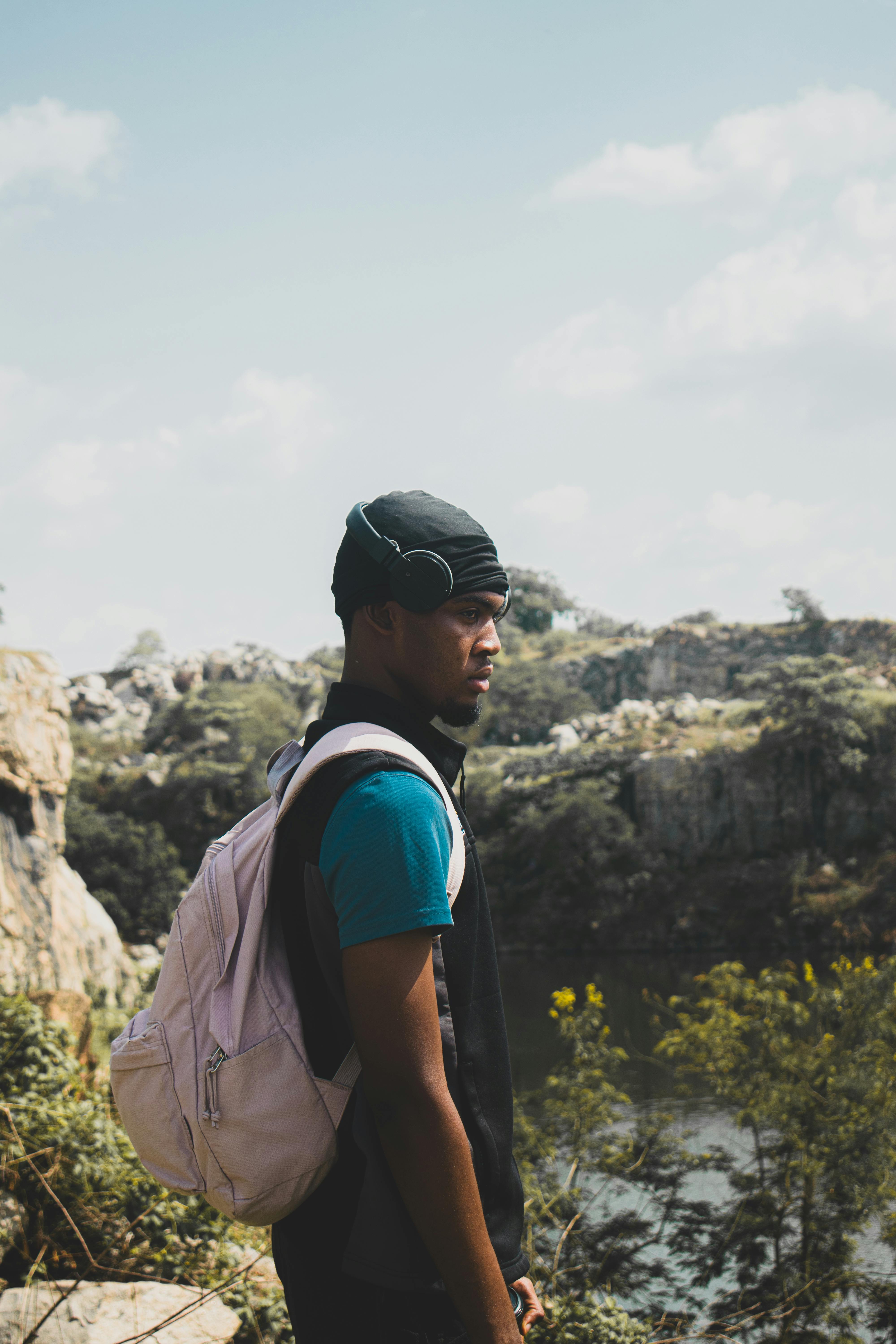 Man in Hat Taking Stuff from a Trunk of the Car · Free Stock Photo