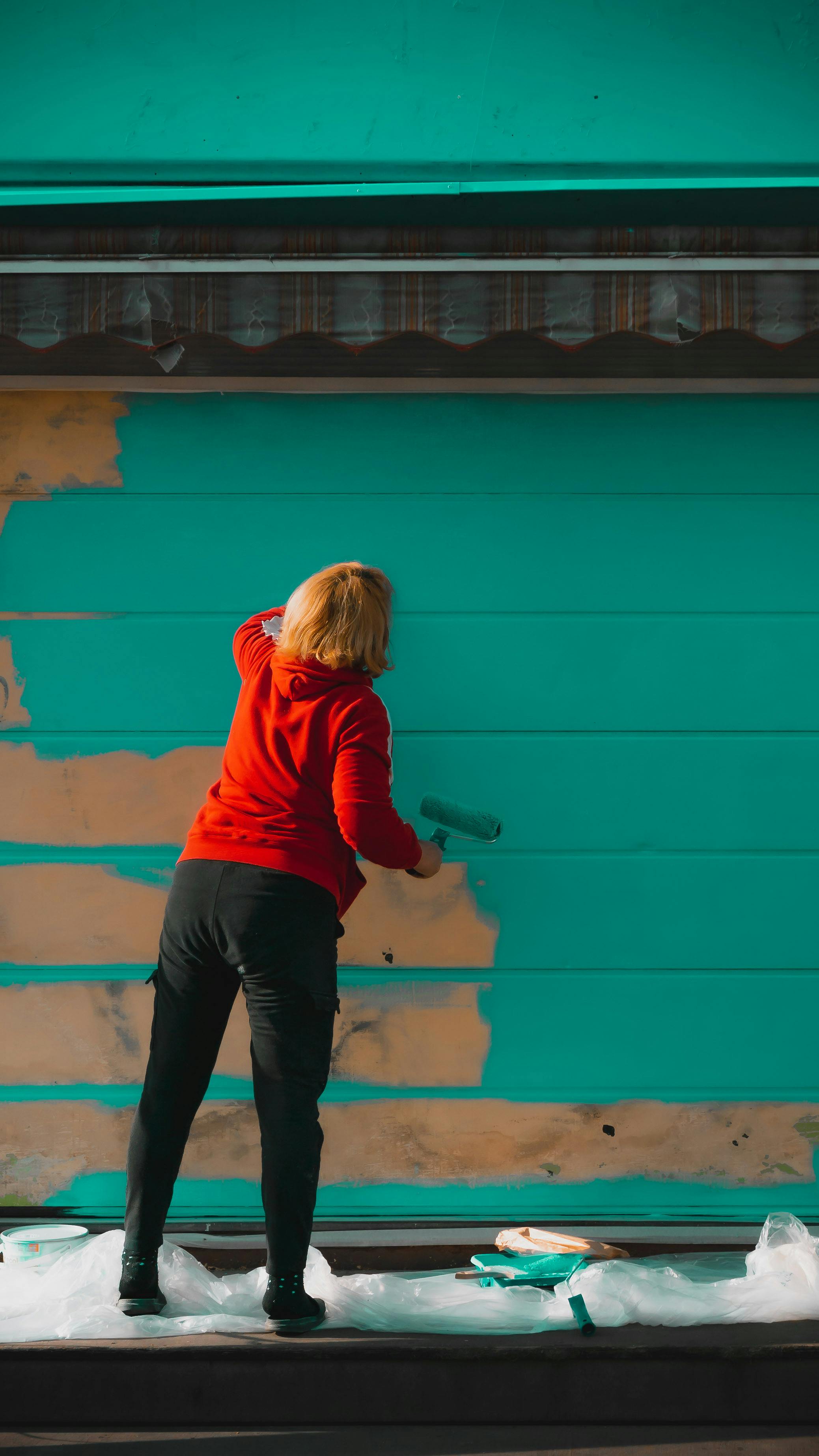 Person Painting Wooden Wall · Free Stock Photo