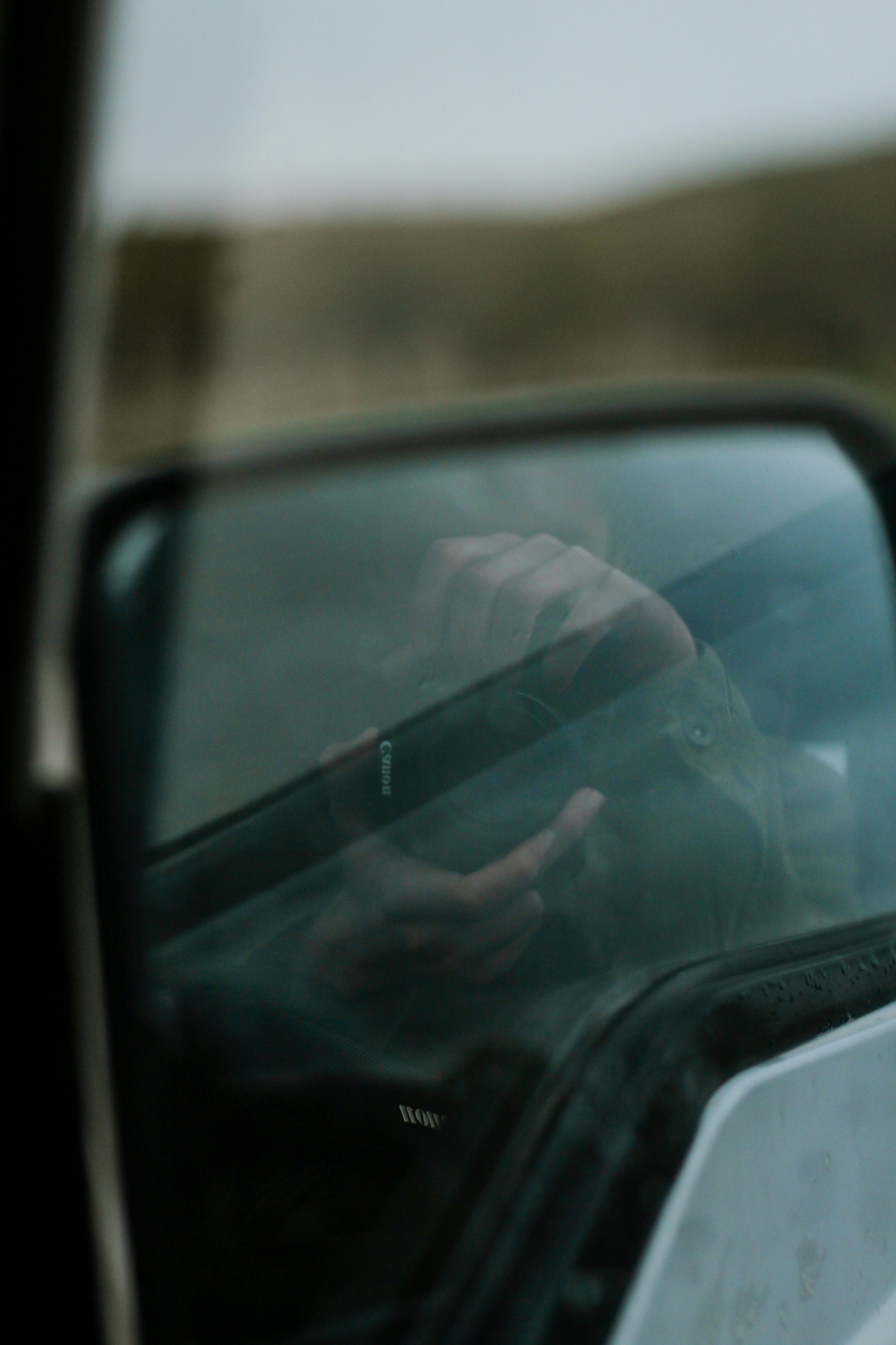 Man Hands with Camera Reflection in Window · Free Stock Photo