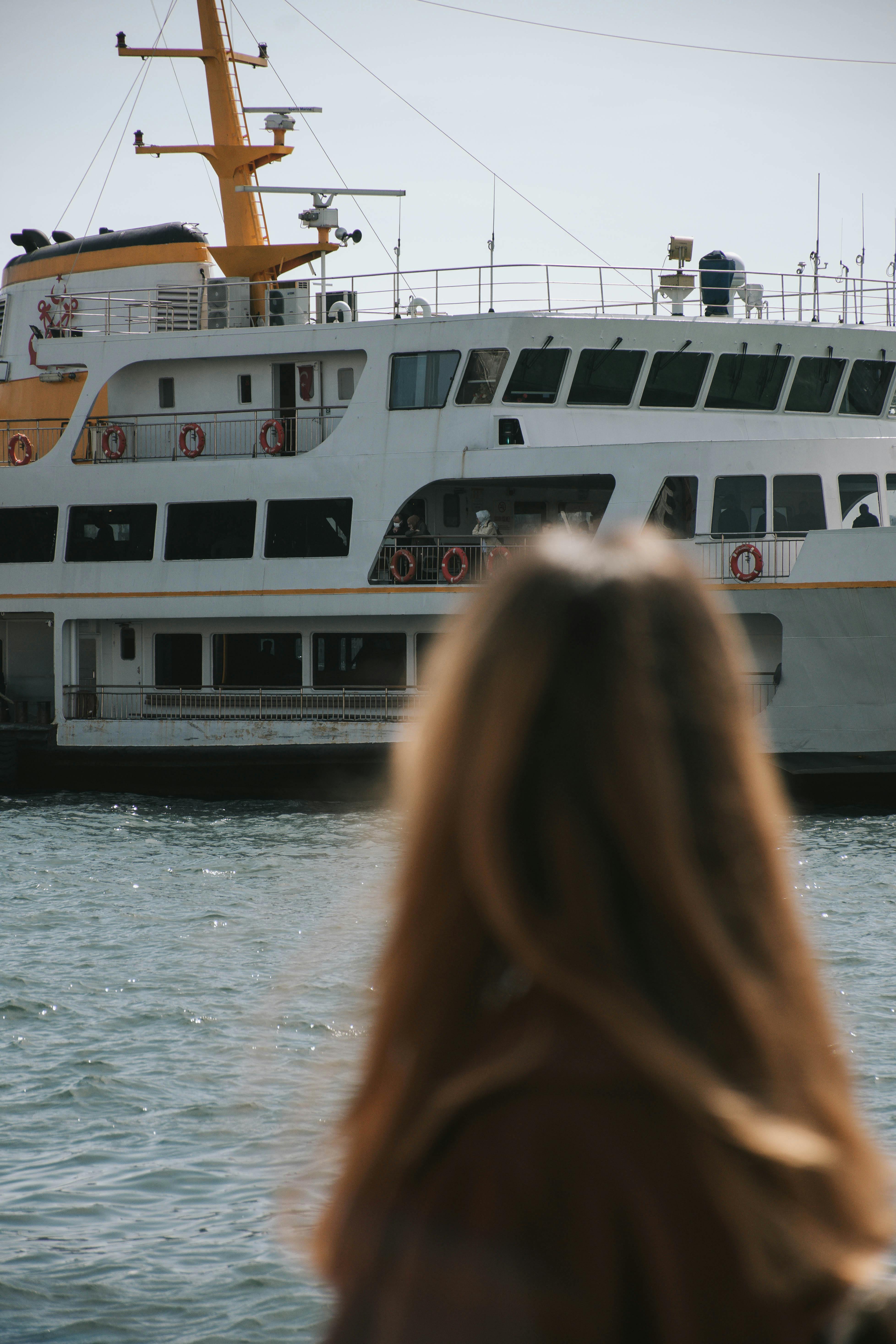 Woman Swimming in Sea and Looking at Ships in Distance · Free Stock Photo