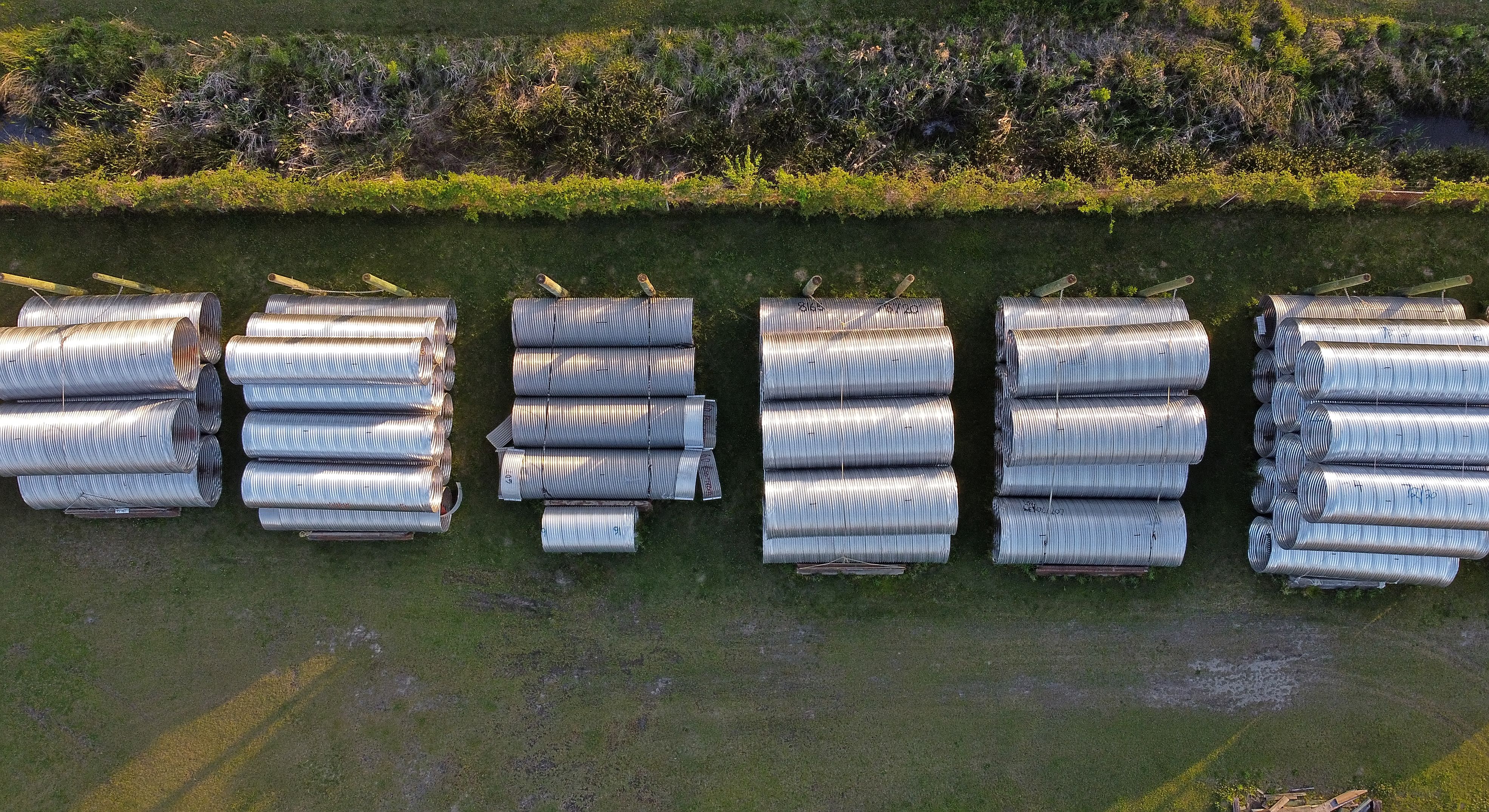Aerial View of Stacks of Large Aluminum Pipes · Free Stock Photo