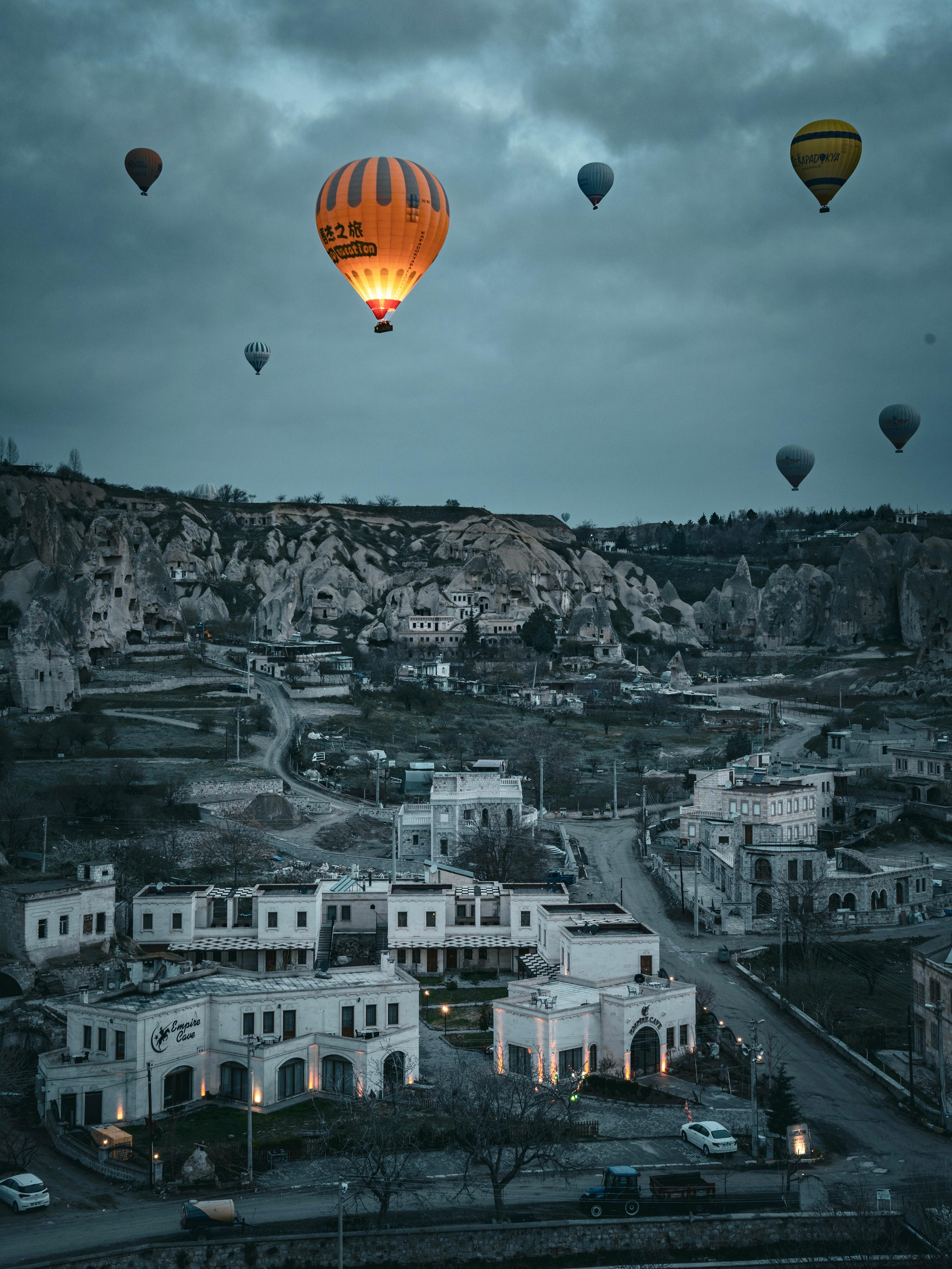 Balloons Flying over Town in Cappadocia · Free Stock Photo