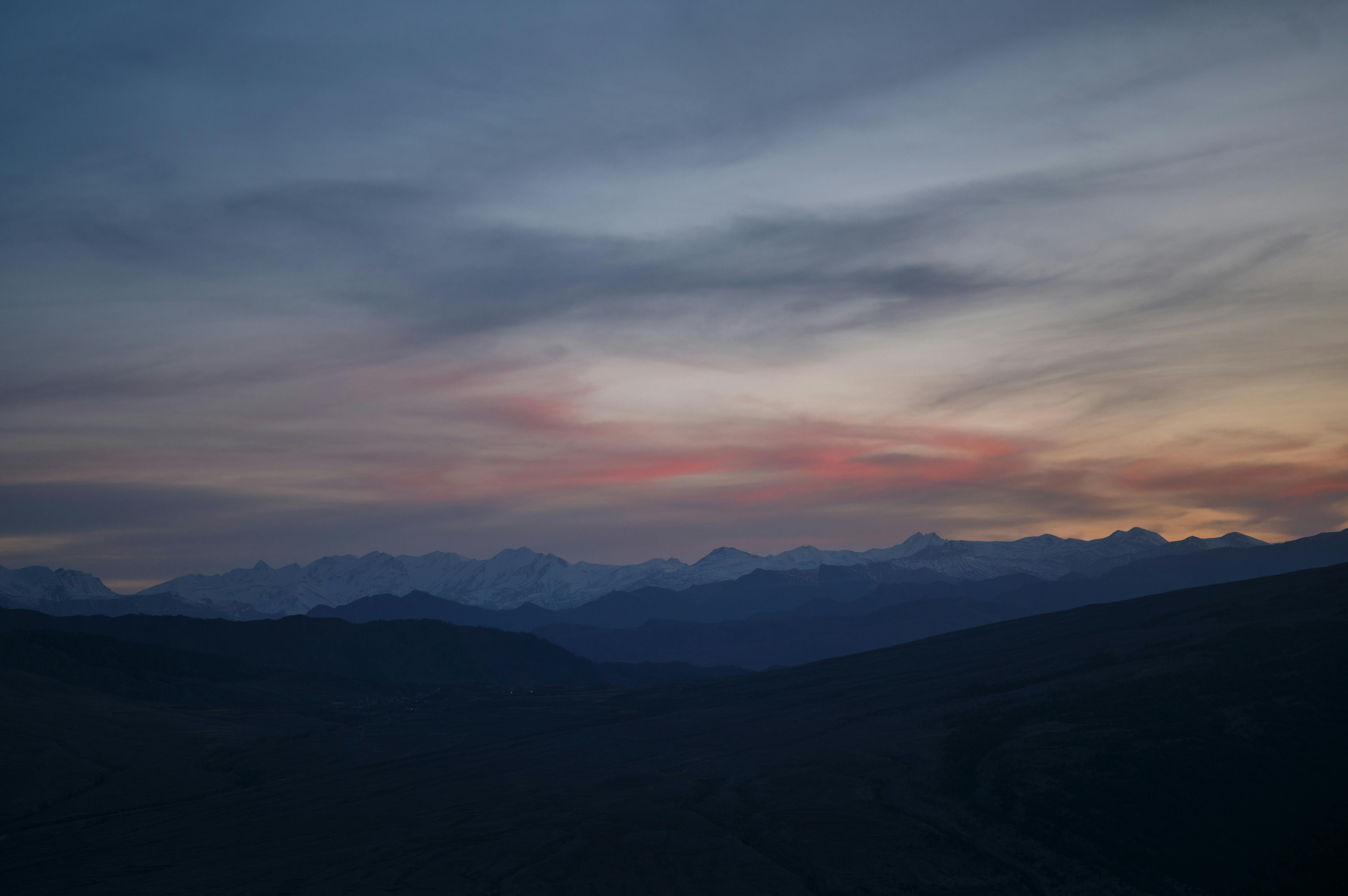 Overcast over Hills and Mountains at Dusk · Free Stock Photo