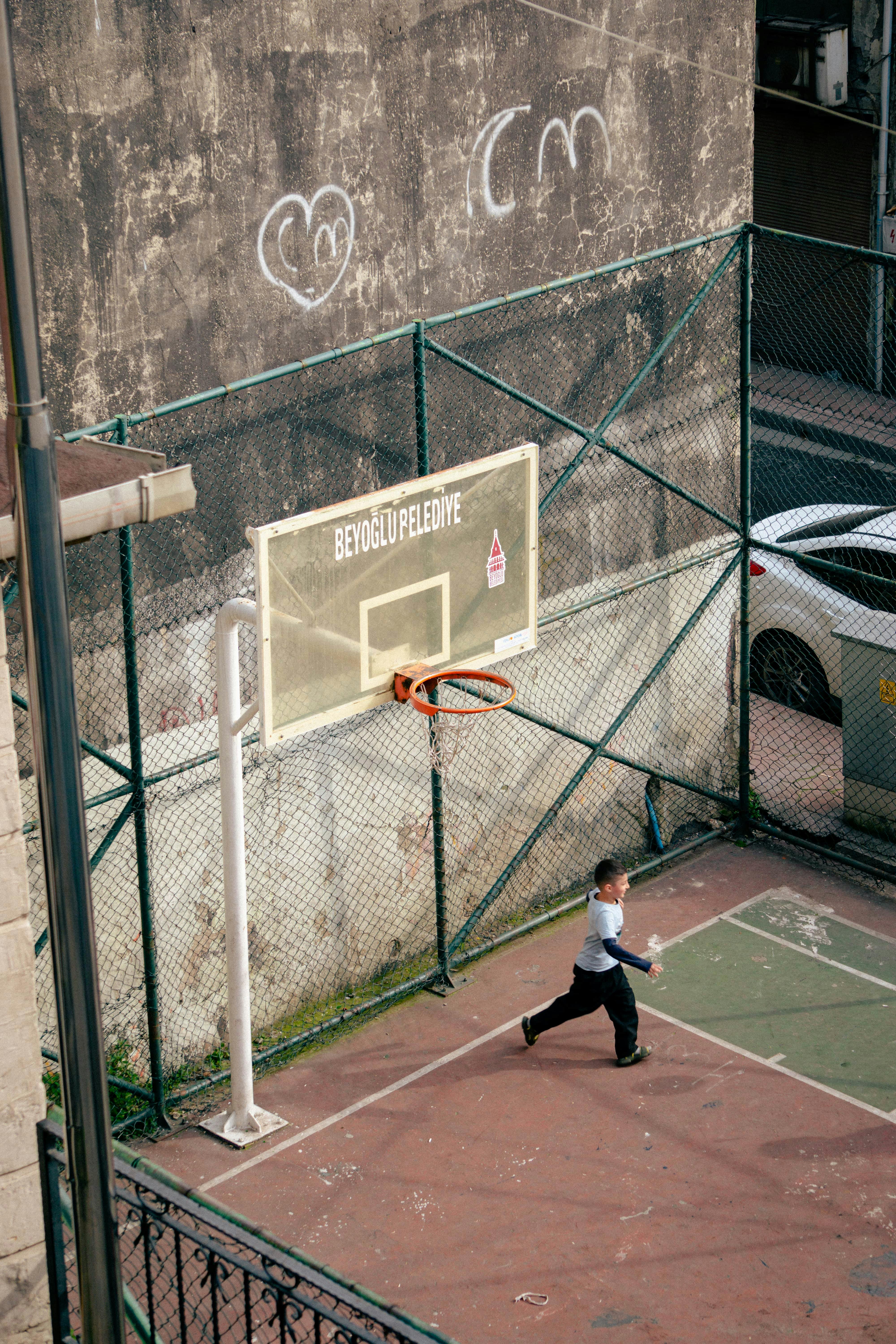 Aerial View of a Boy Running on a Basketball Court in City · Free Stock ...