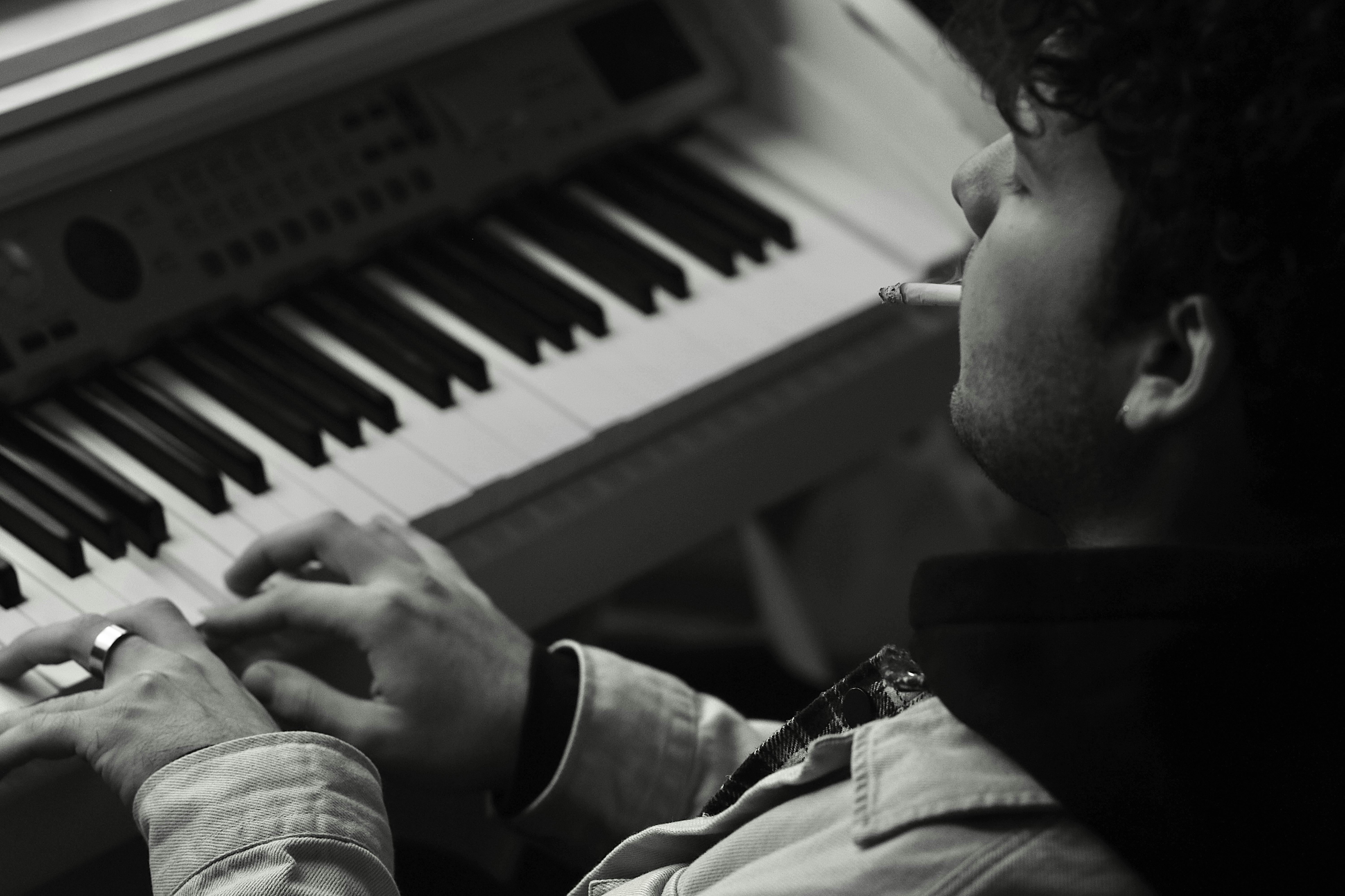 Man Smoking and Playing Keyboard · Free Stock Photo