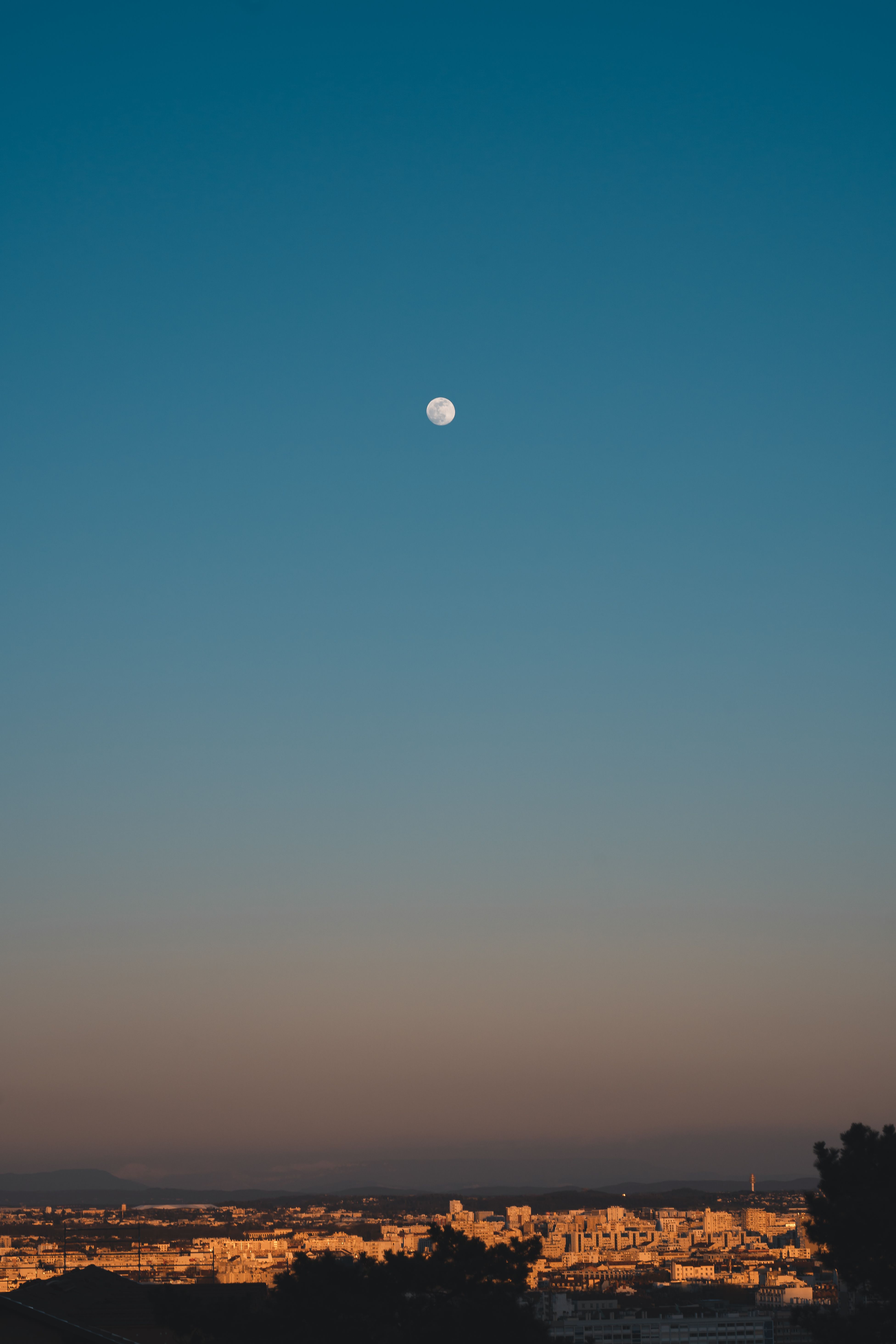 Moon on Clear Sky over Town at Sunset · Free Stock Photo