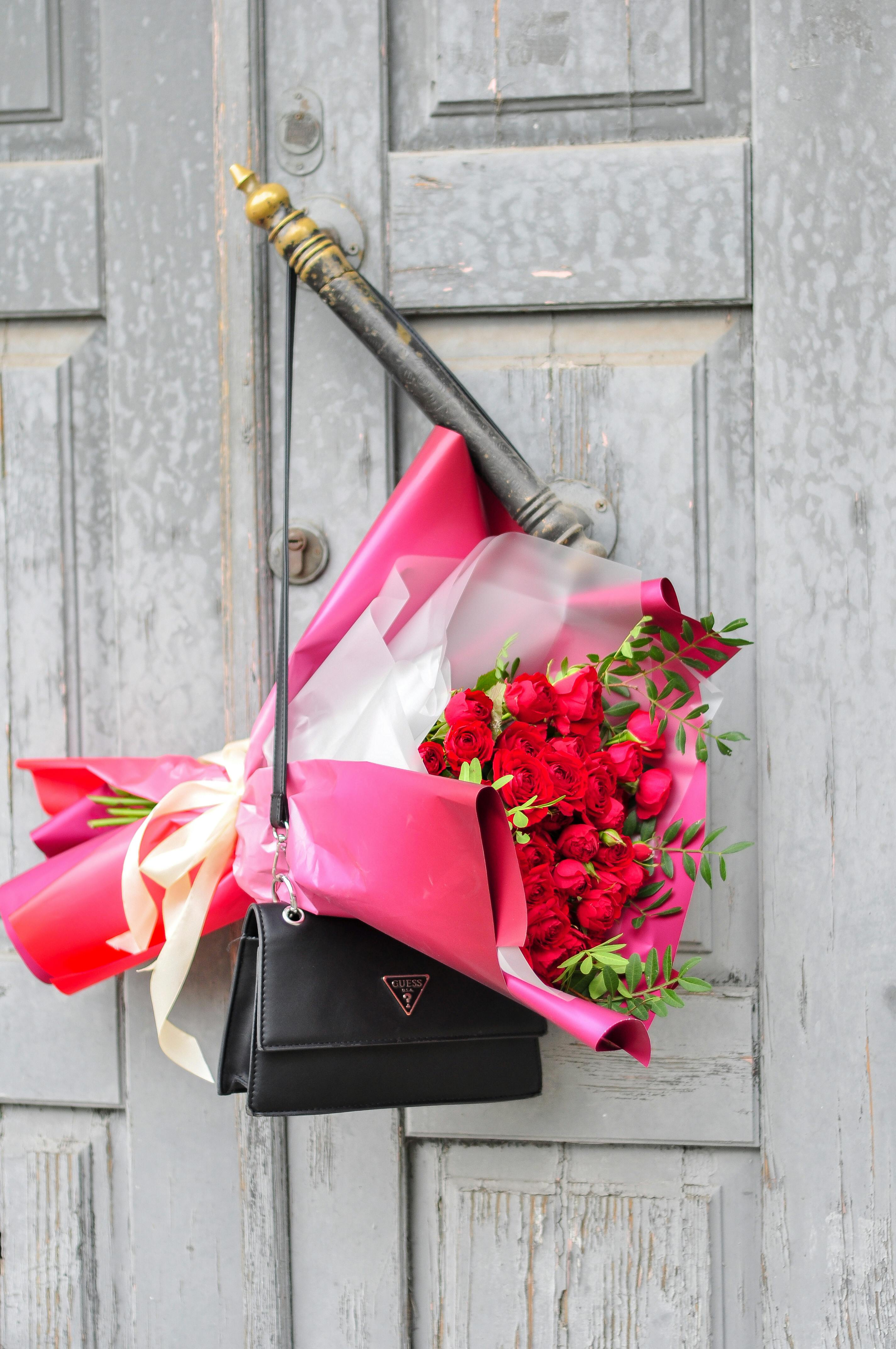 A Purse and a Bouquet of Red Roses · Free Stock Photo