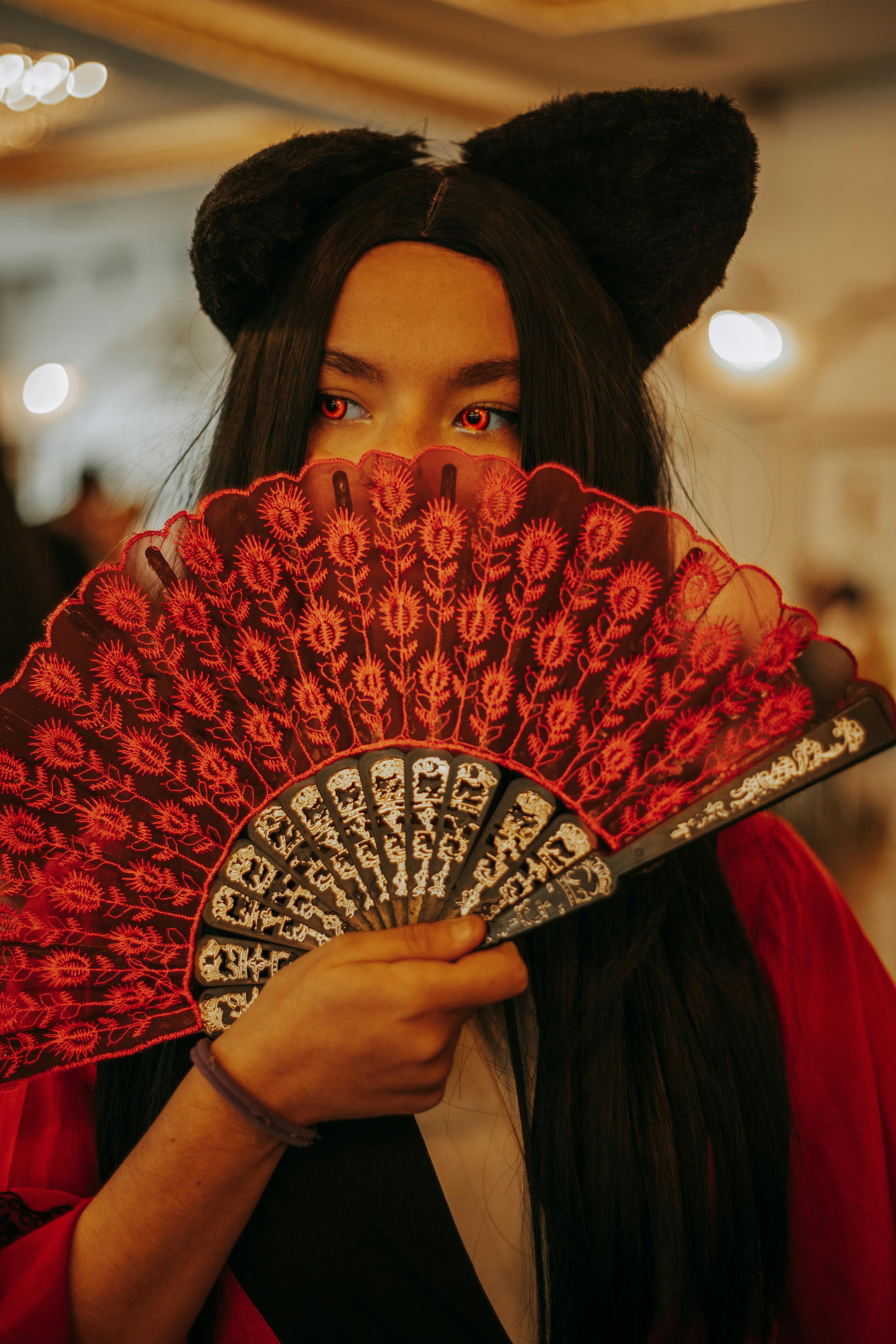 Woman Hiding Face behind Paper Fan · Free Stock Photo