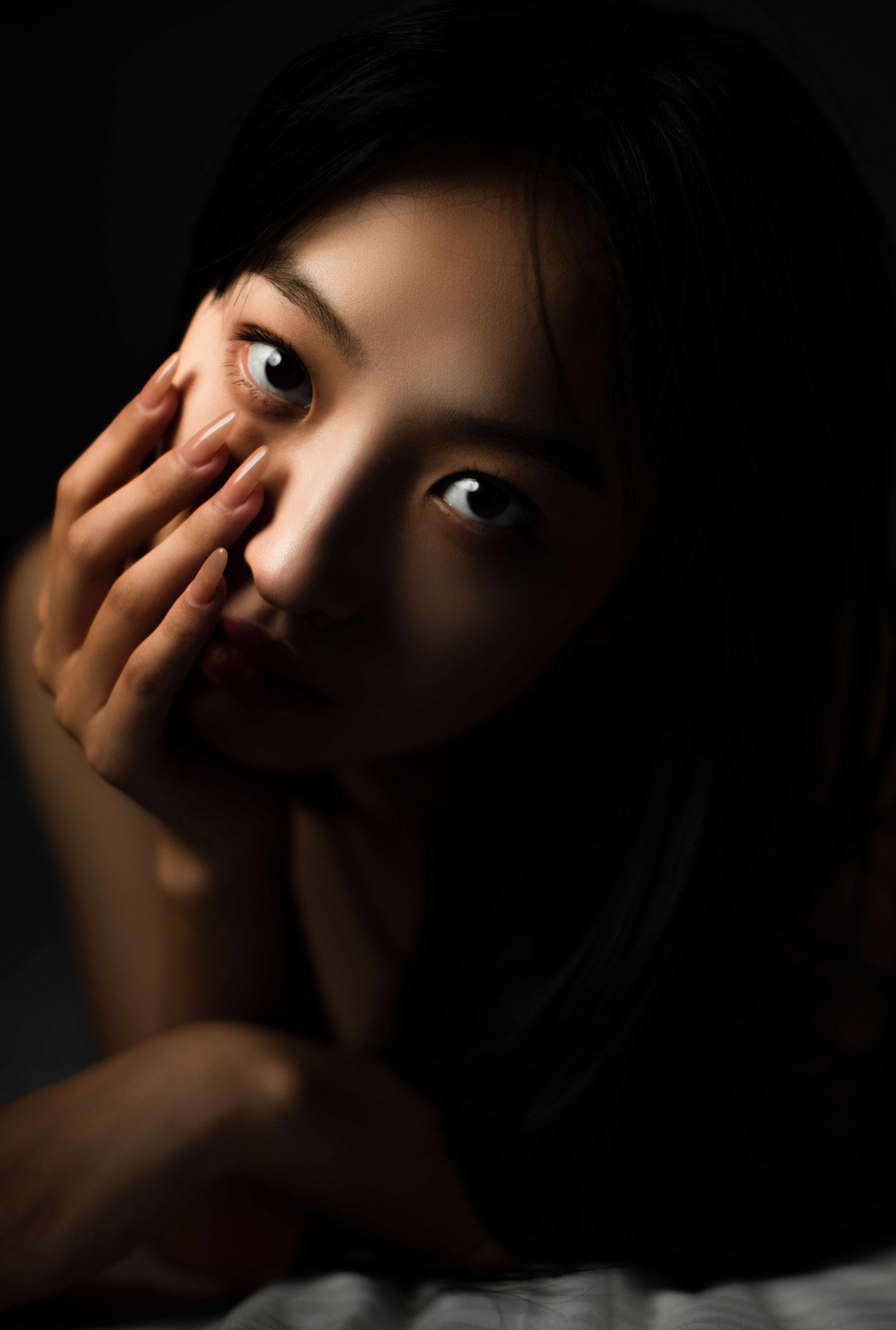 Portrait of a Woman with her Face on Hand · Free Stock Photo