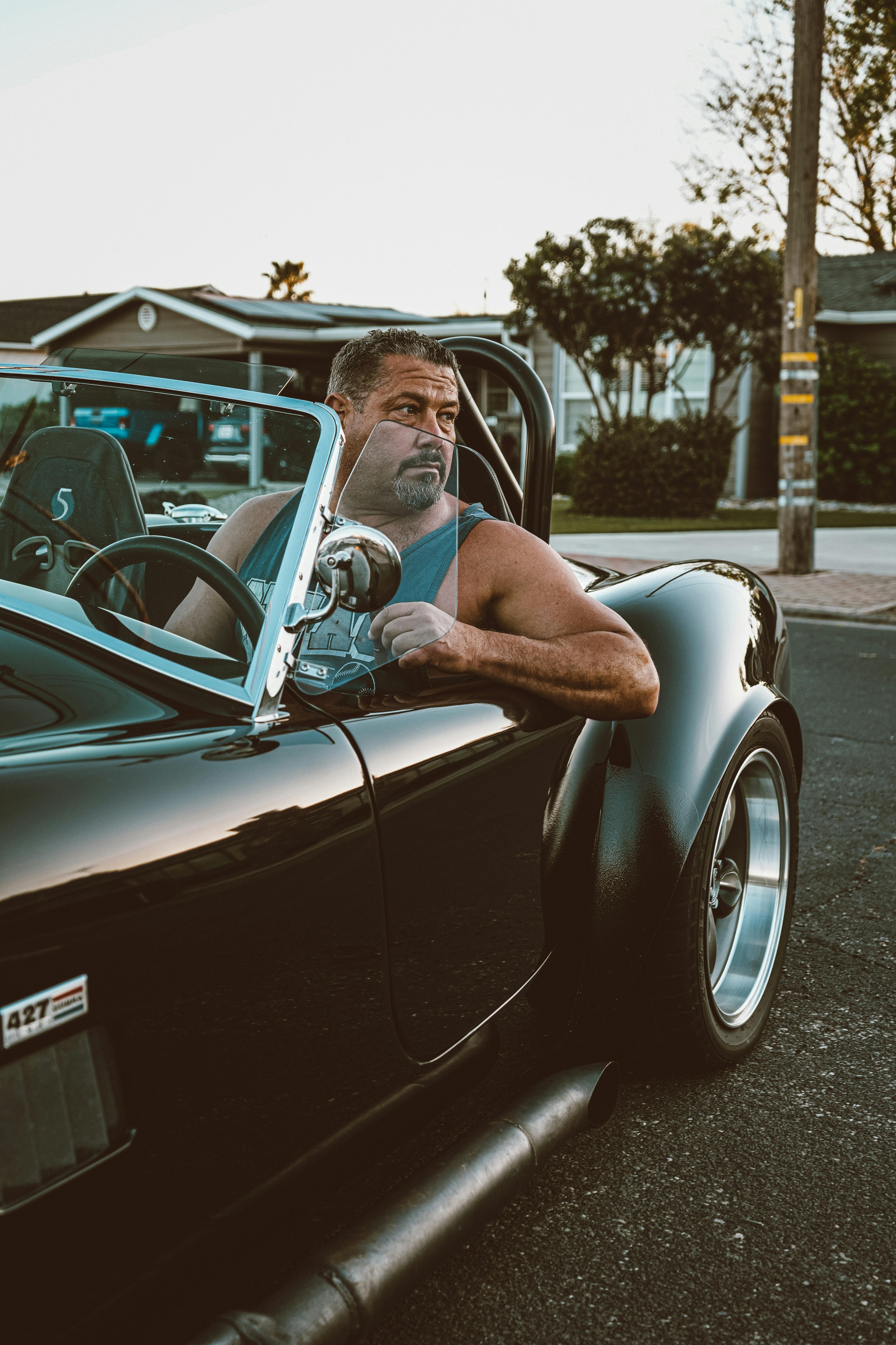 Man Sitting in a Vintage Convertible · Free Stock Photo