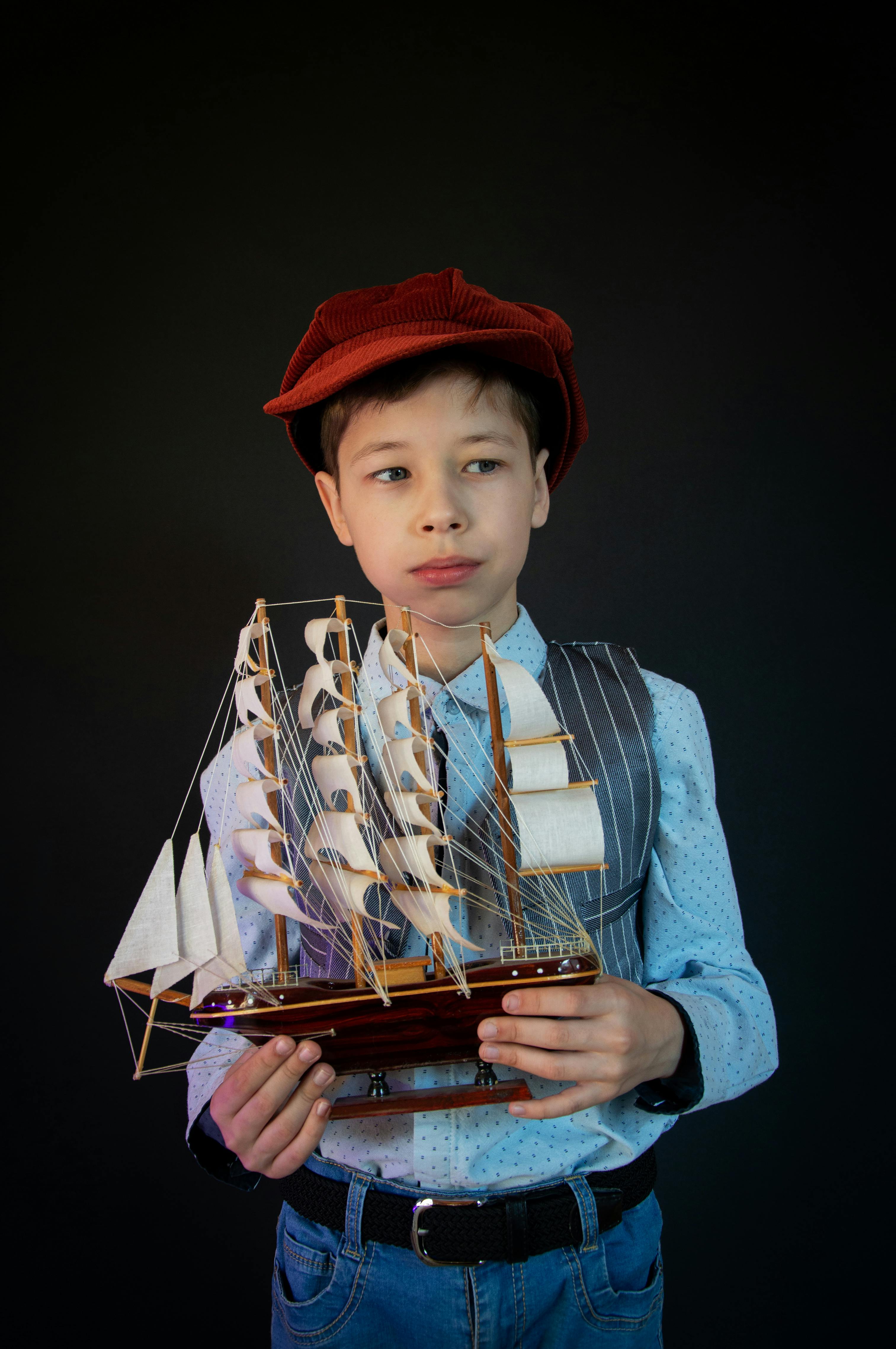 Boy Posing with Ship Model · Free Stock Photo