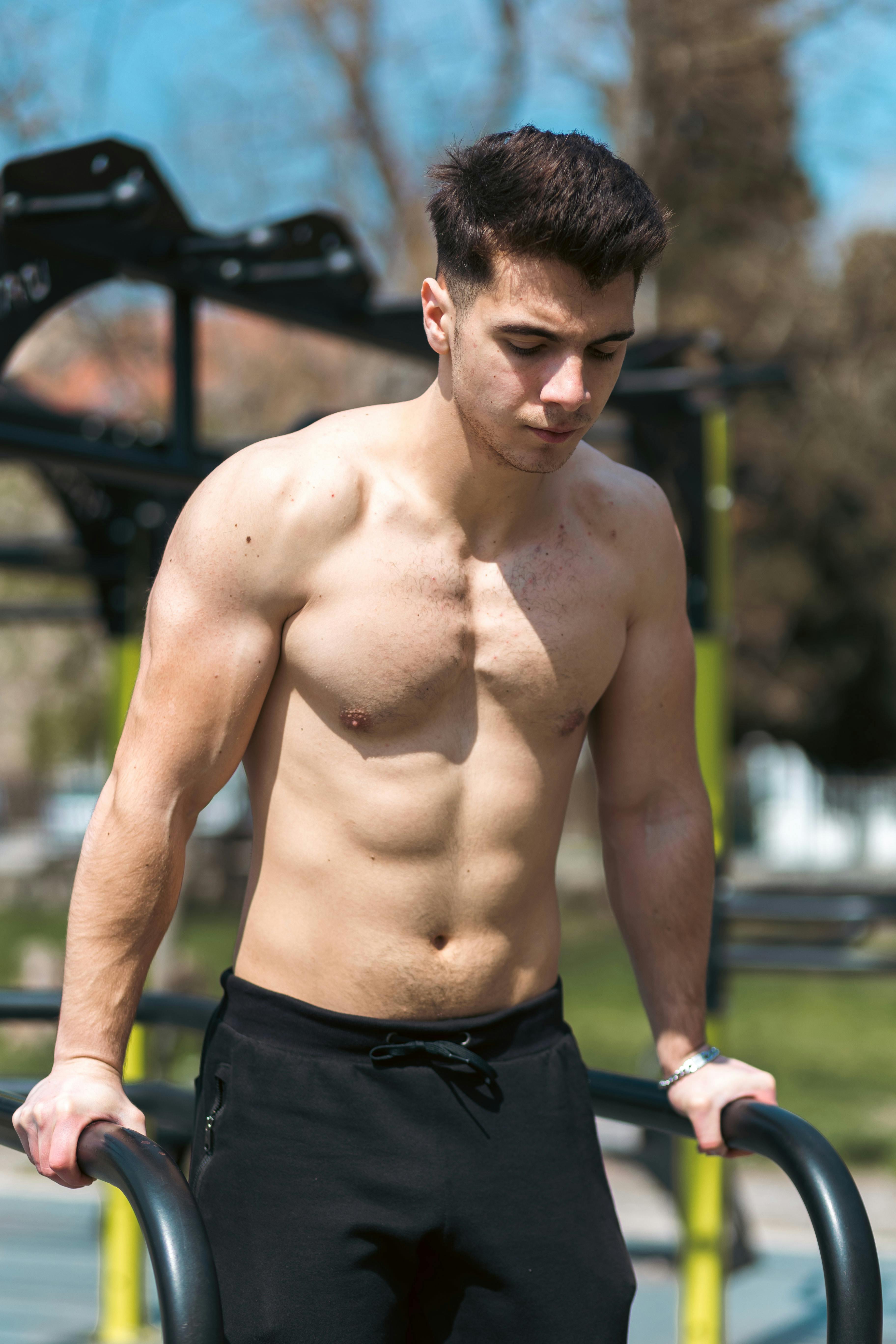 Back View of a Muscular Man Exercising in a Gym · Free Stock Photo
