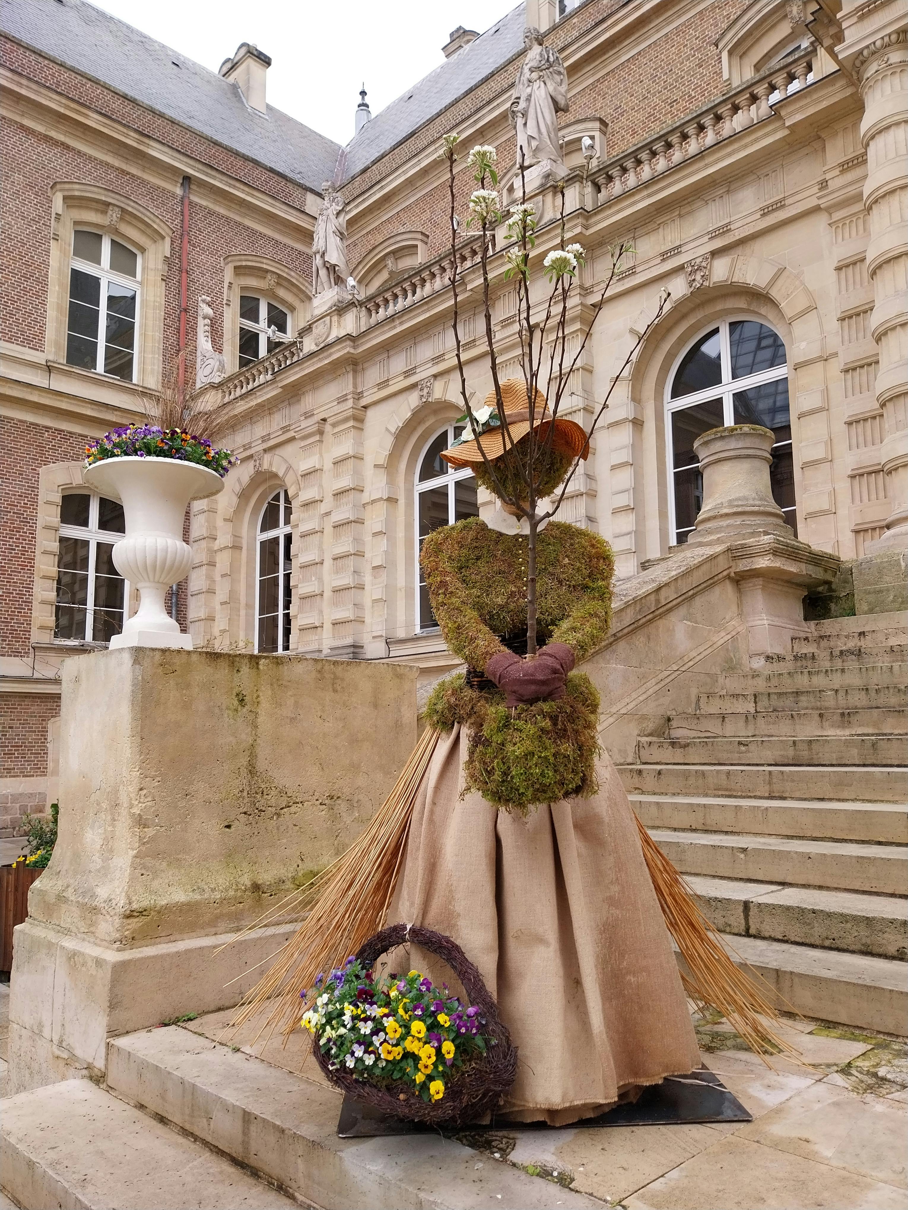Tree Cut into Shape of Woman Holding Rake · Free Stock Photo
