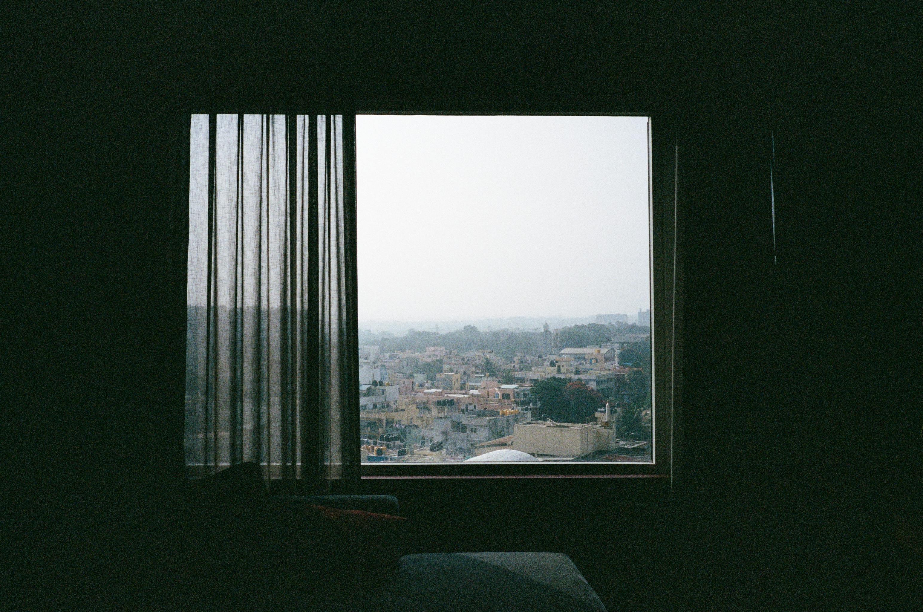 View of a City from a Window of a High Floor Apartment · Free Stock Photo