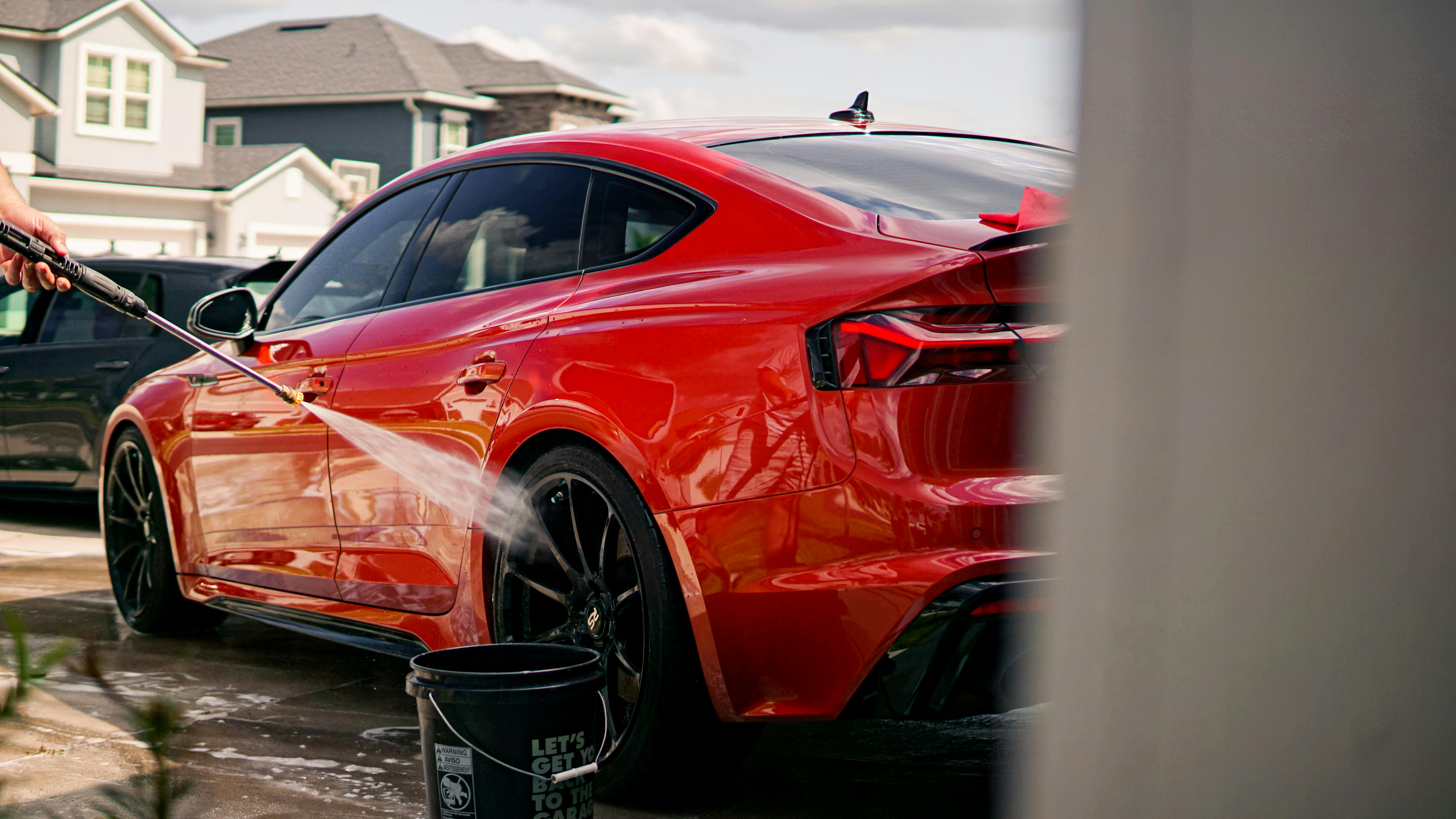 Red Car Being Washed in a Residential District · Free Stock Photo