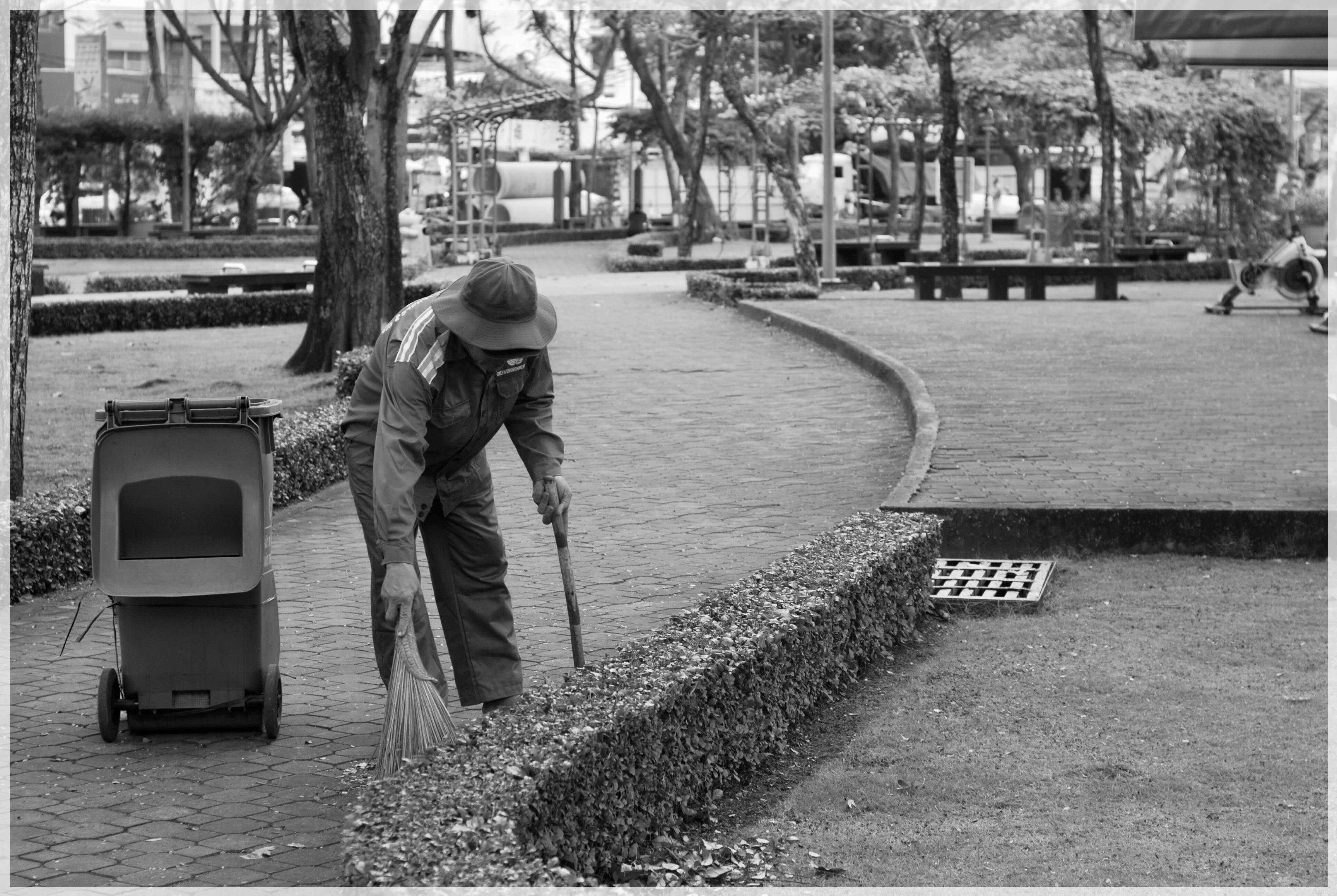 Man Cleaning the Walkway in a Park · Free Stock Photo