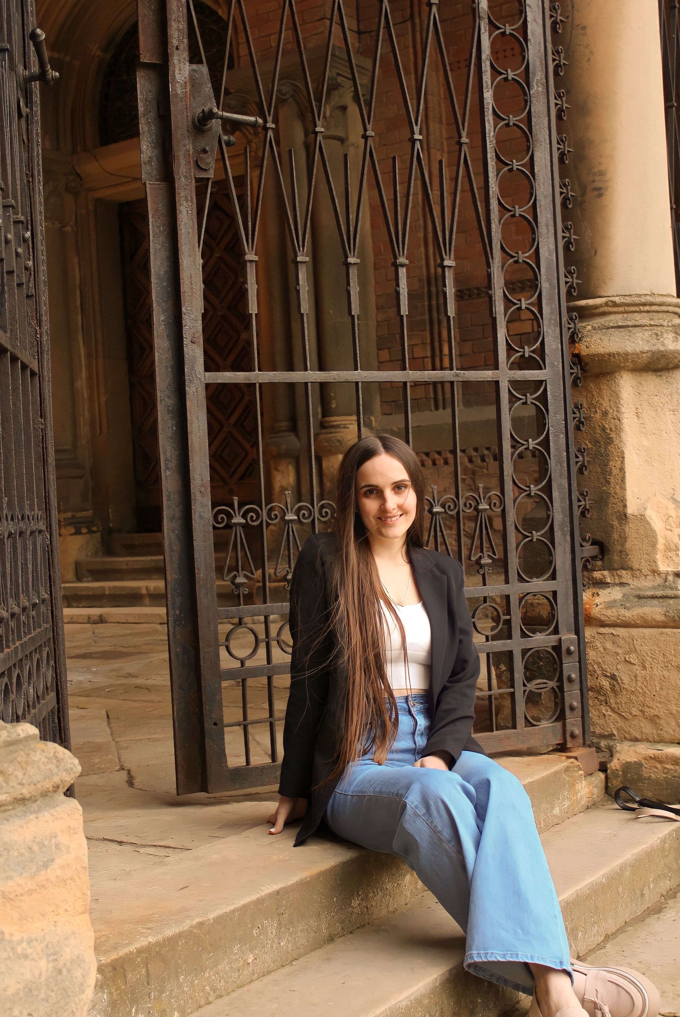 Young Woman Sitting on the Steps of a Building · Free Stock Photo