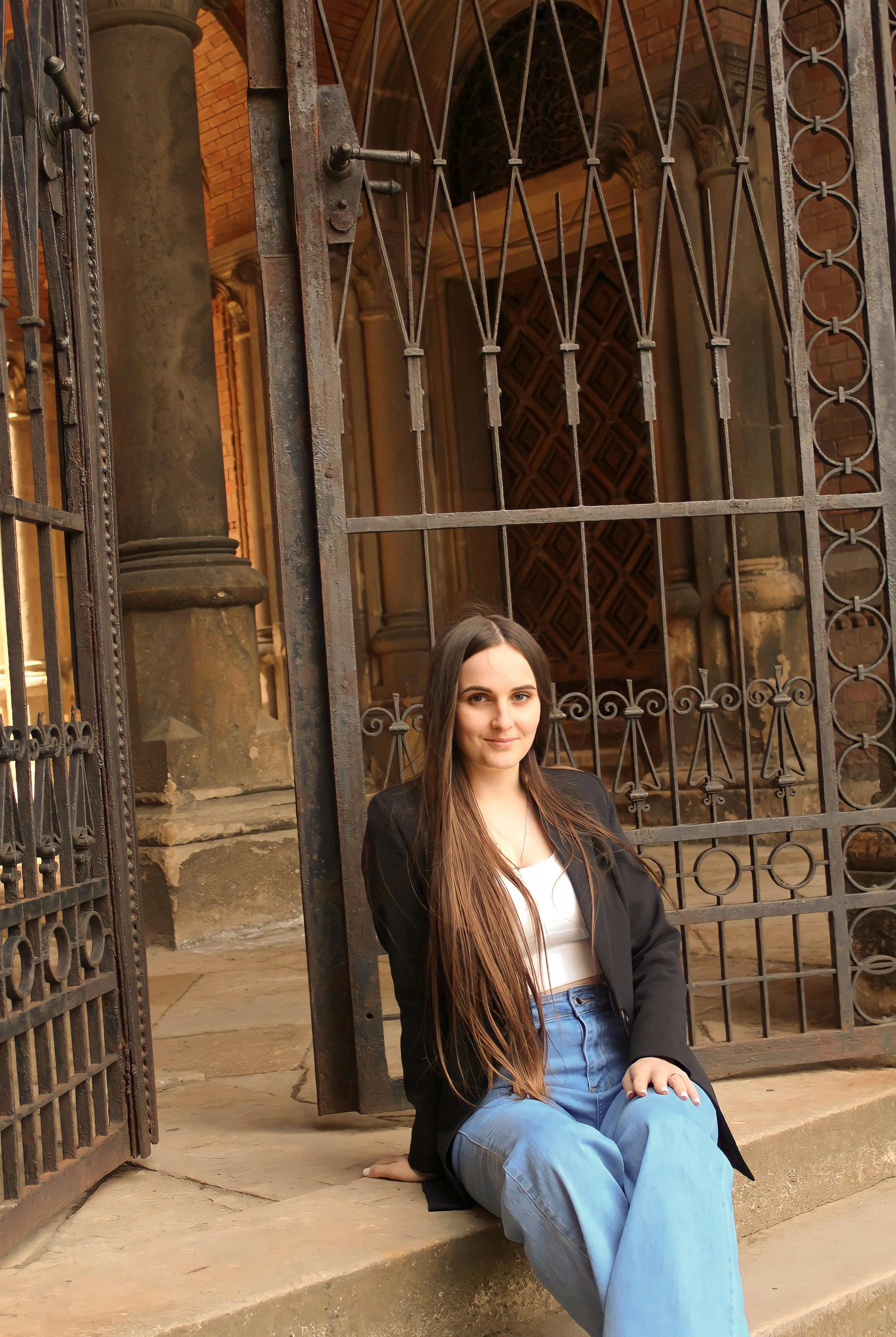 Young Brunette Woman in Blue Jeans and Black Jacket Sitting at Church ...