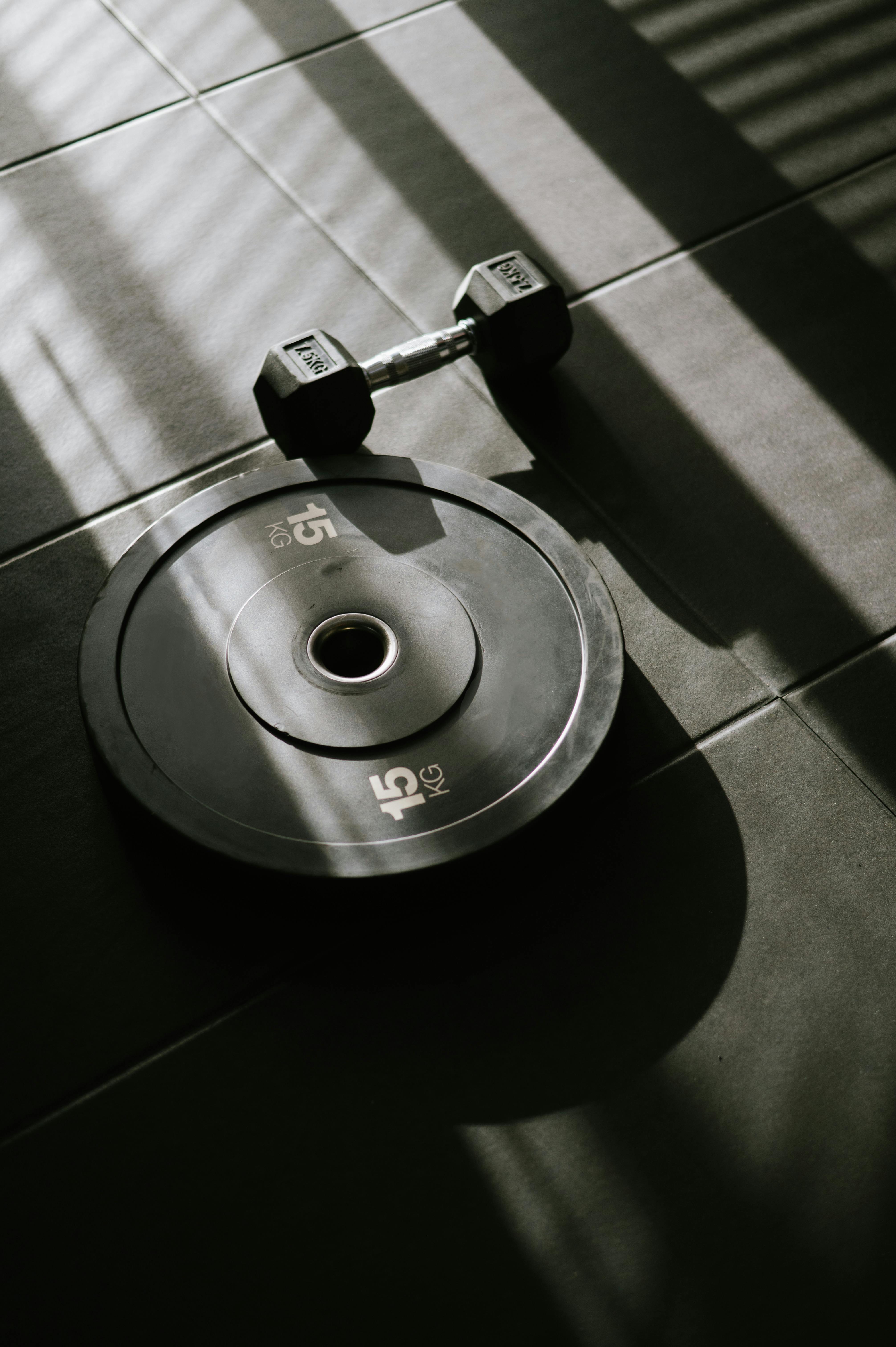Body Building Equipment in Sunlight and Shadow · Free Stock Photo