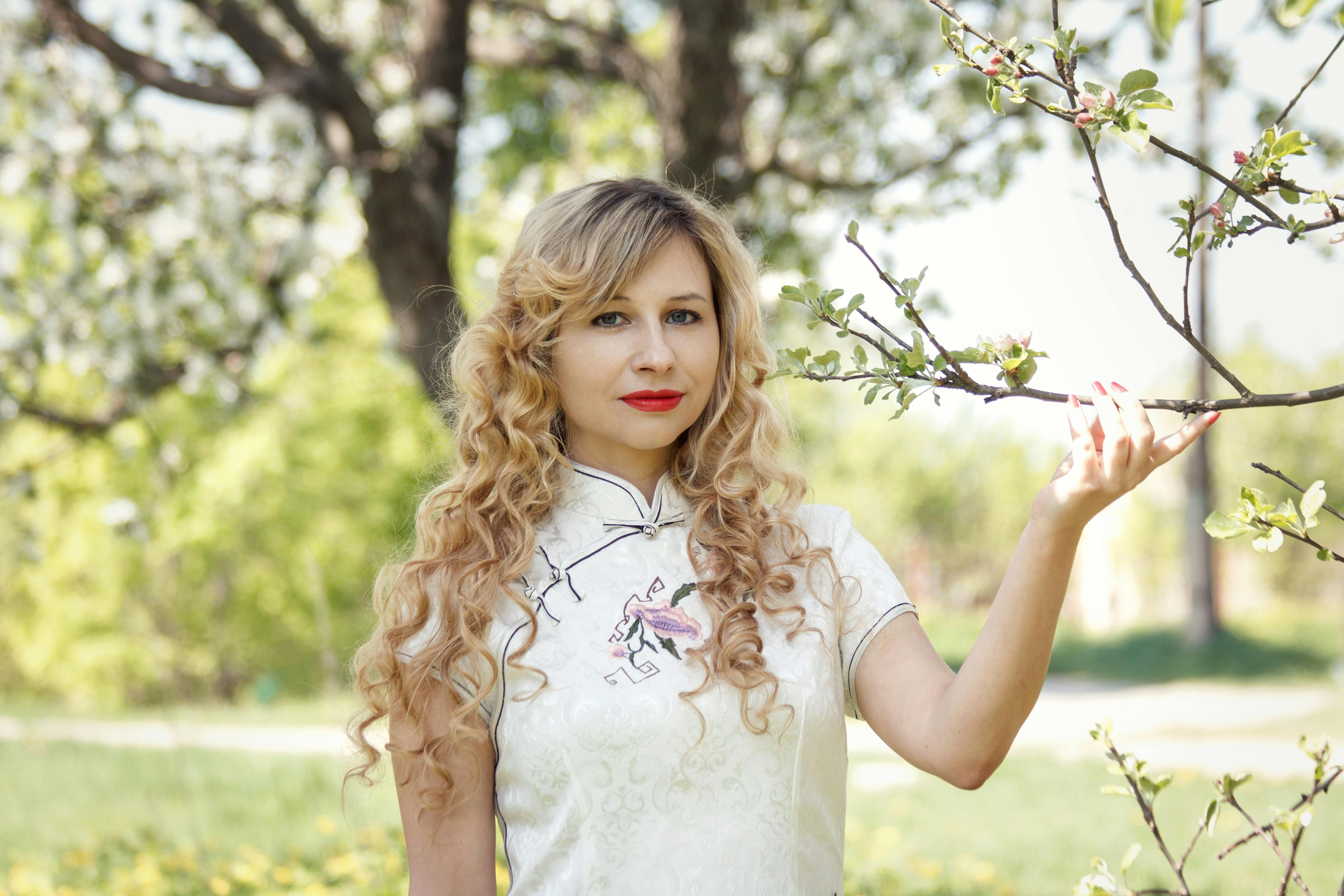 Woman Holding Tree Branch · Free Stock Photo