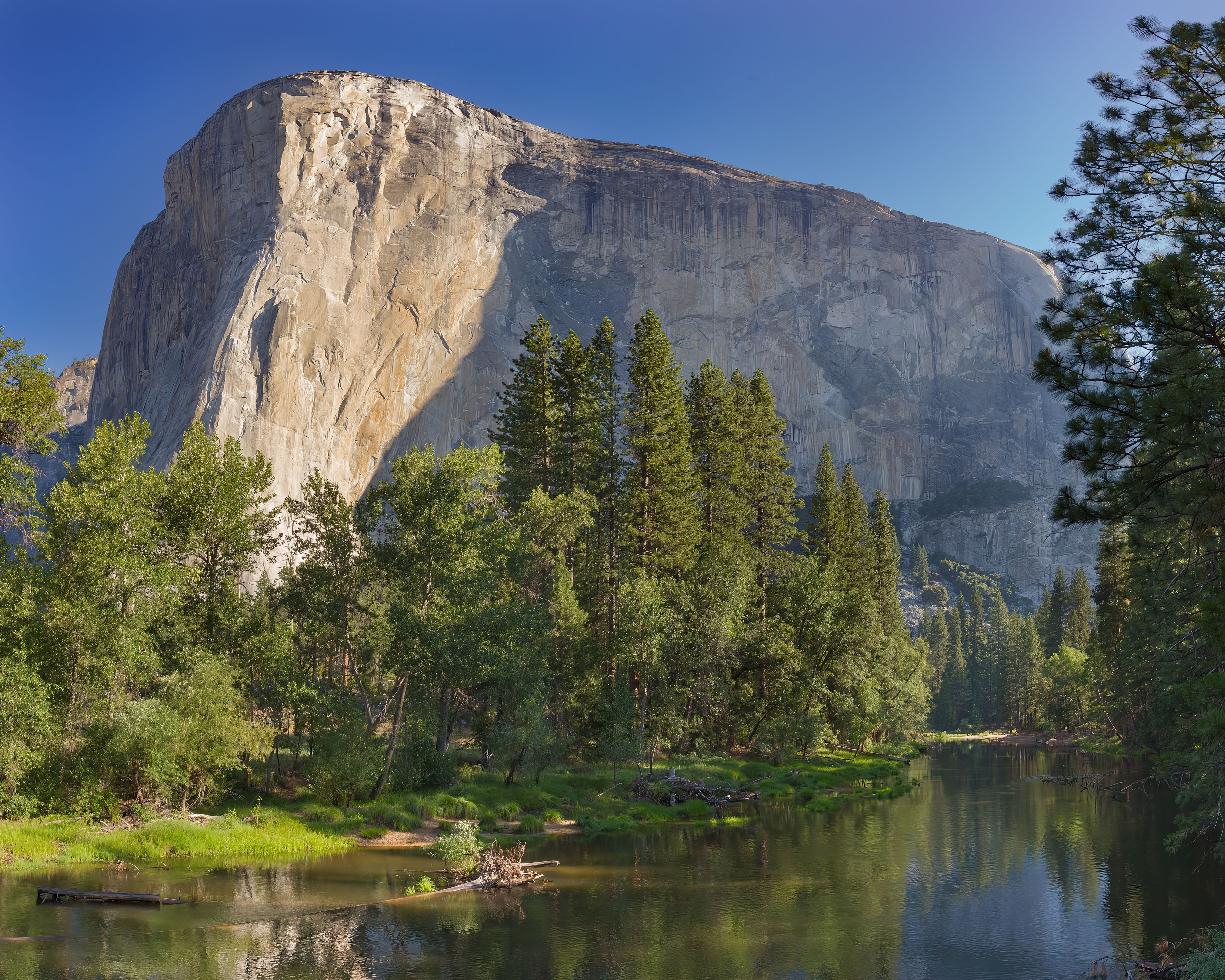 Scenic View of a Huge Rock Formation and a Lake · Free Stock Photo