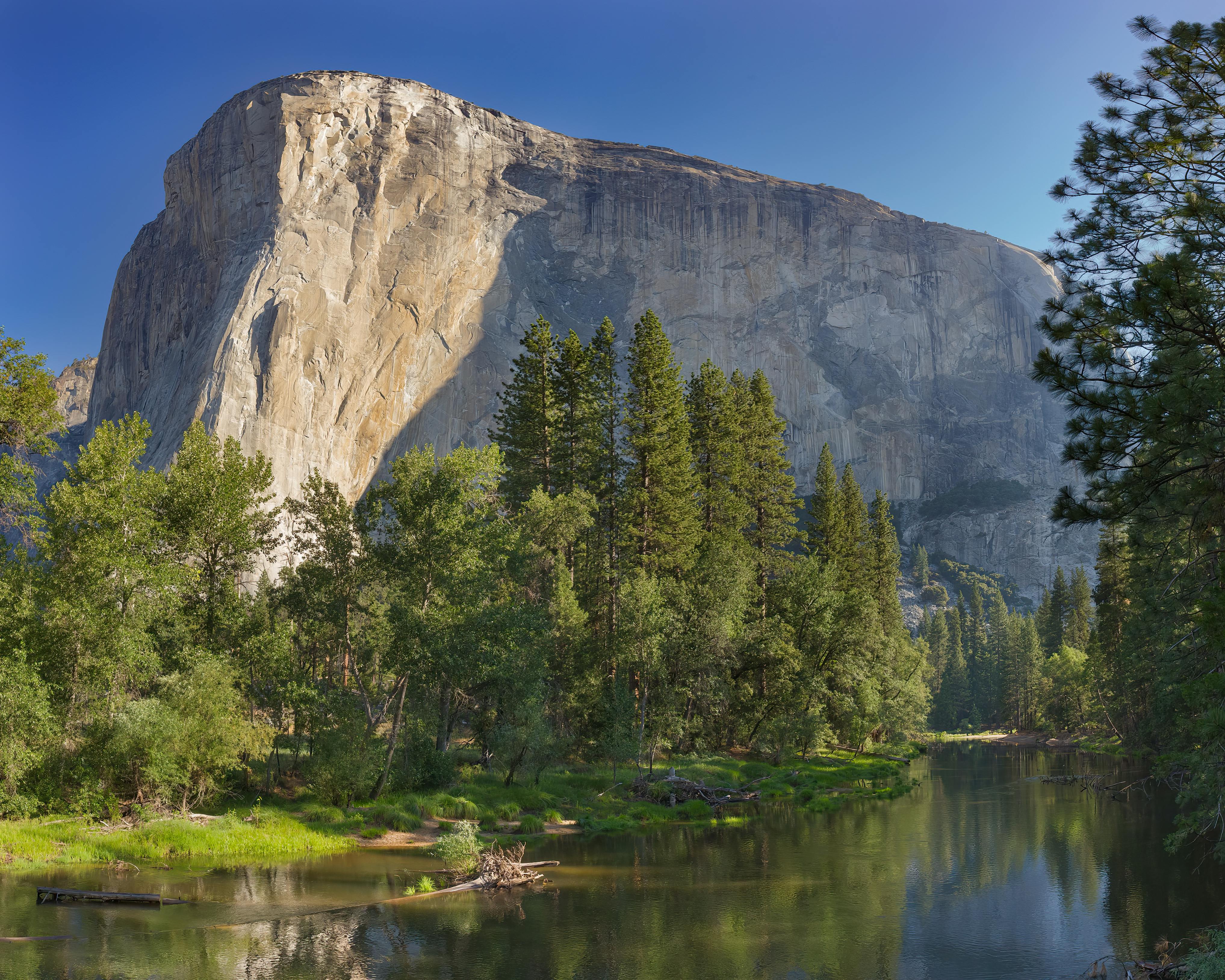 Scenic View of a Huge Rock Formation and a Lake · Free Stock Photo