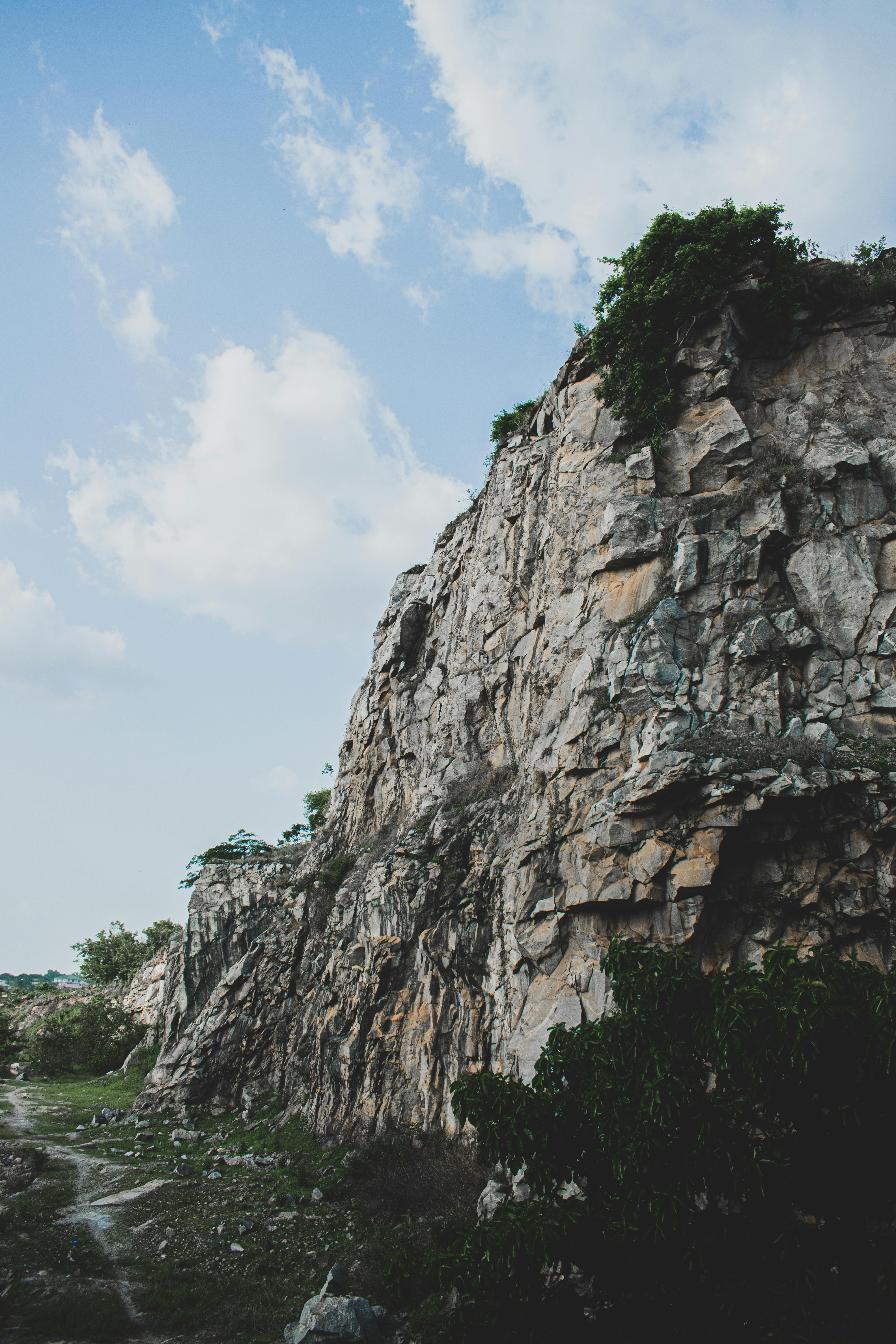 Low Angle Shot of a Rocky Cliff · Free Stock Photo