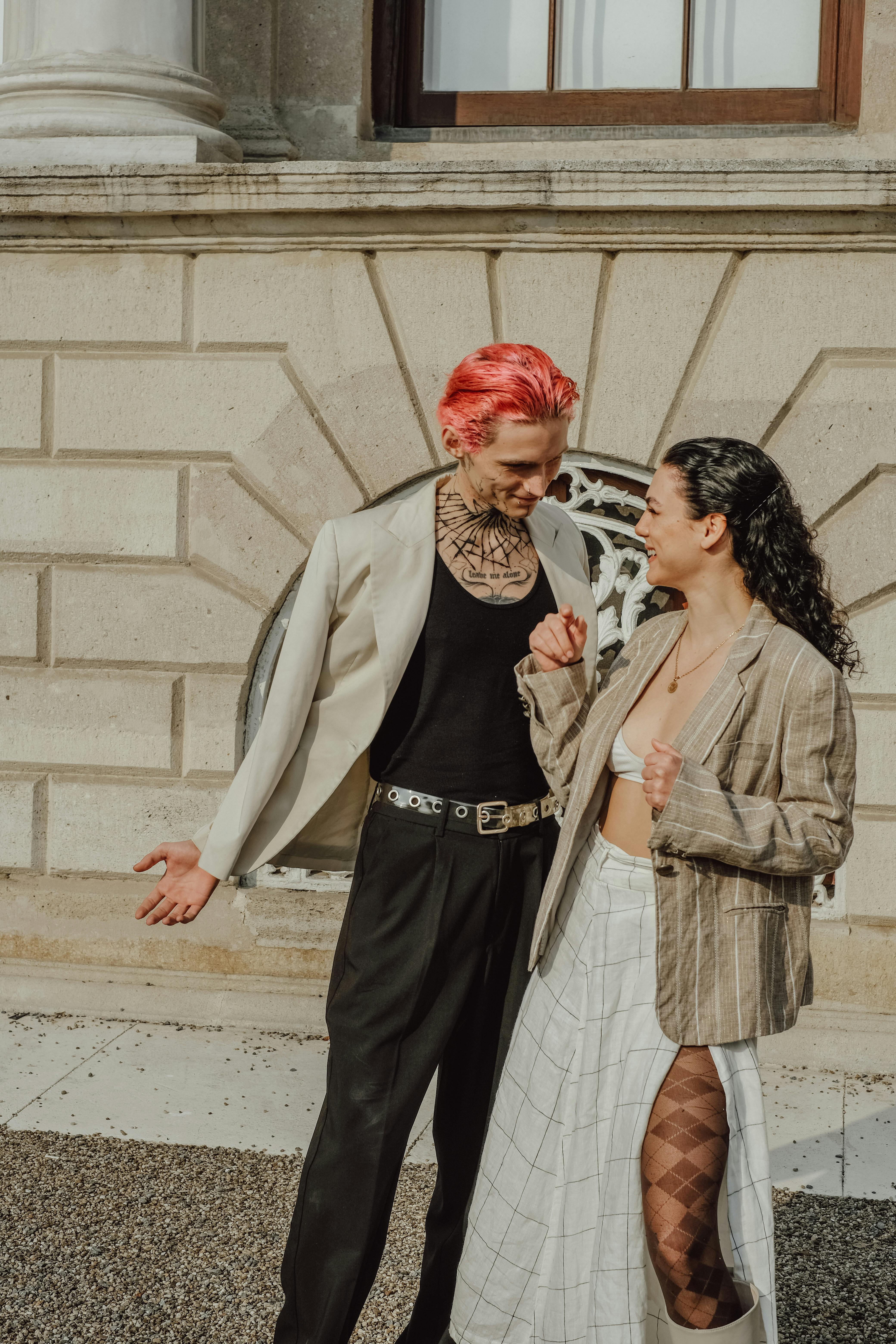 Young Couple in a Flirting Pose in Front of a Building · Free Stock Photo