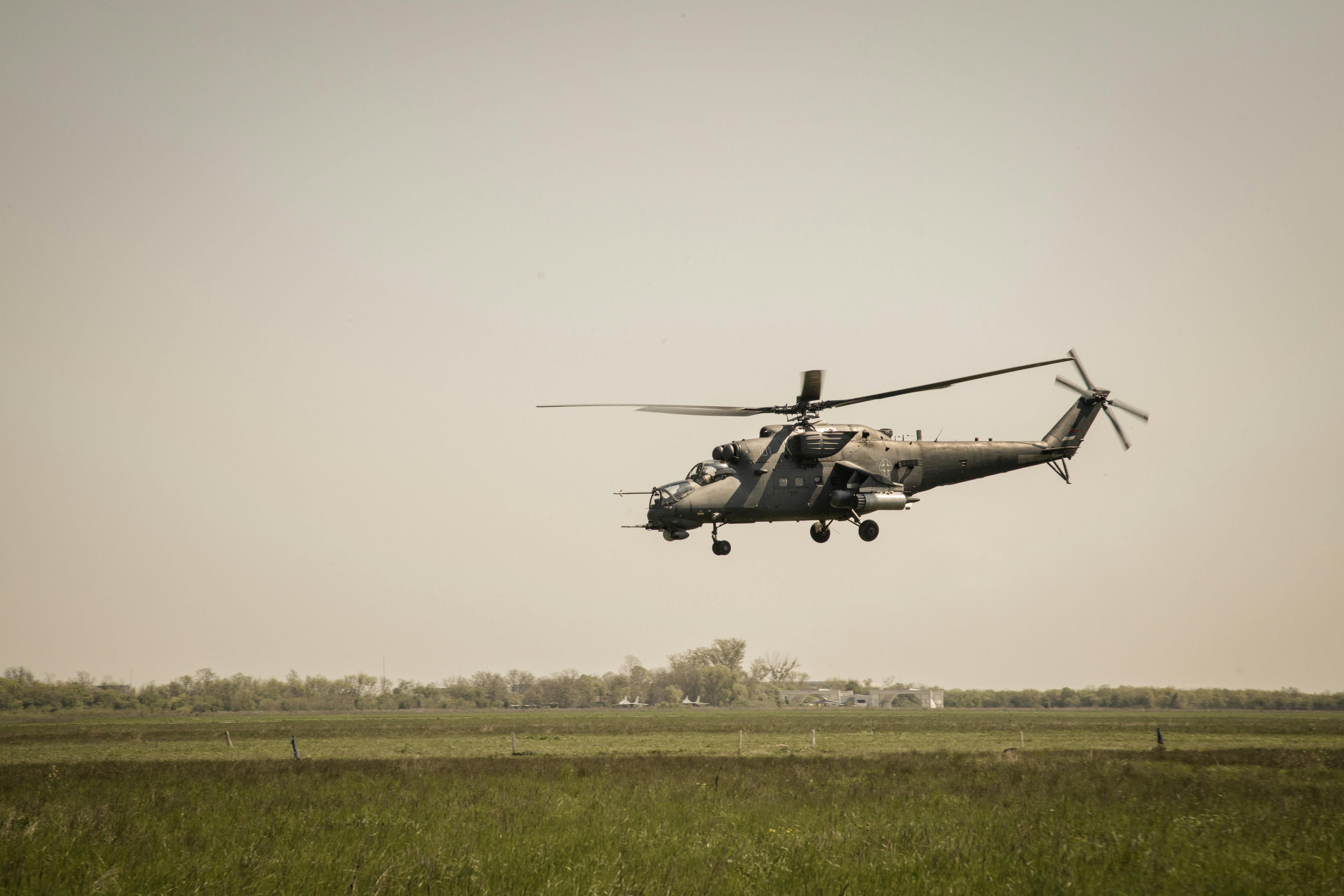 Military Helicopter Flying over Meadow · Free Stock Photo
