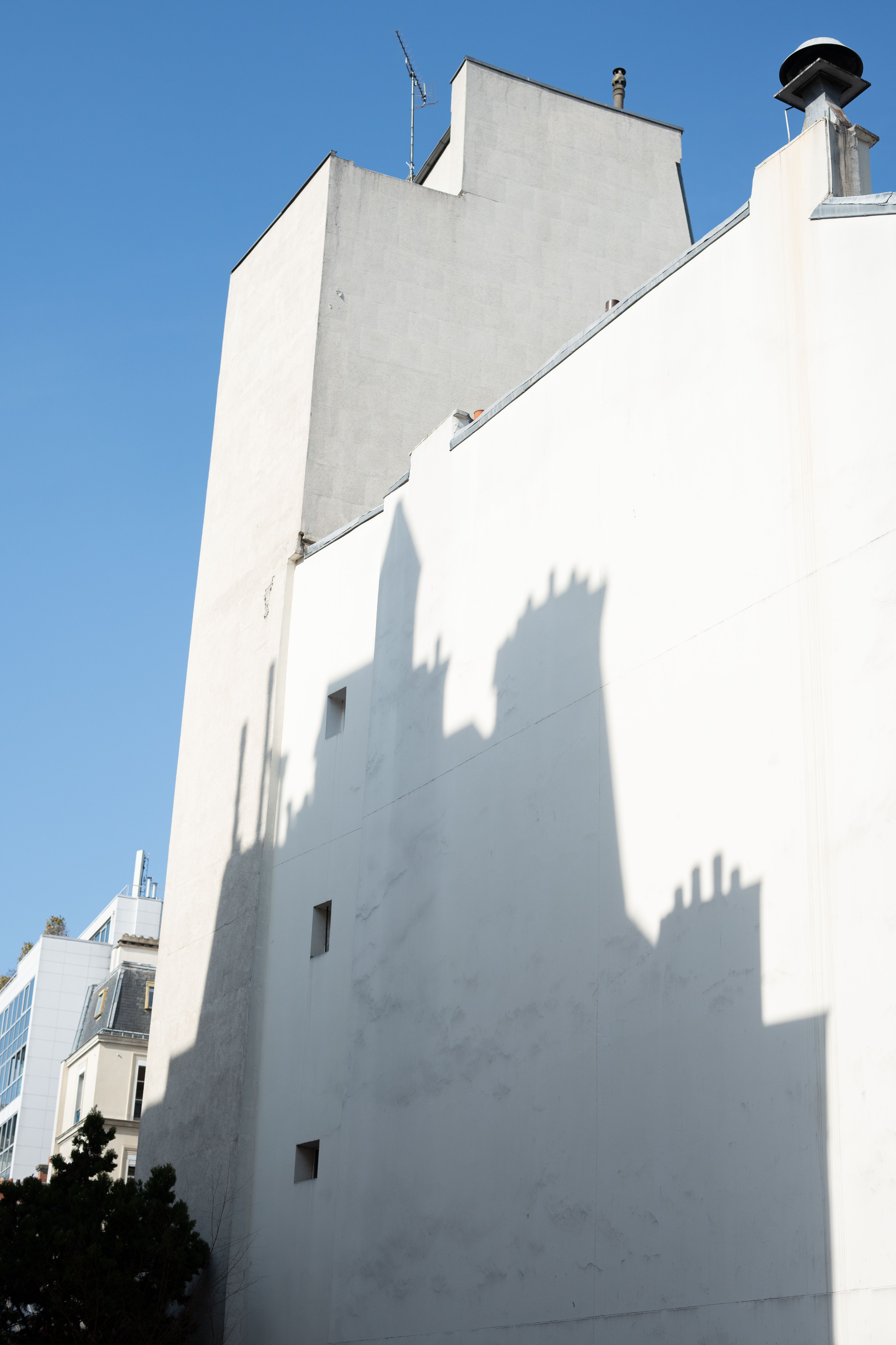 Close-up of a Pole Attached to a Building Casting Shadow on the Wall ...