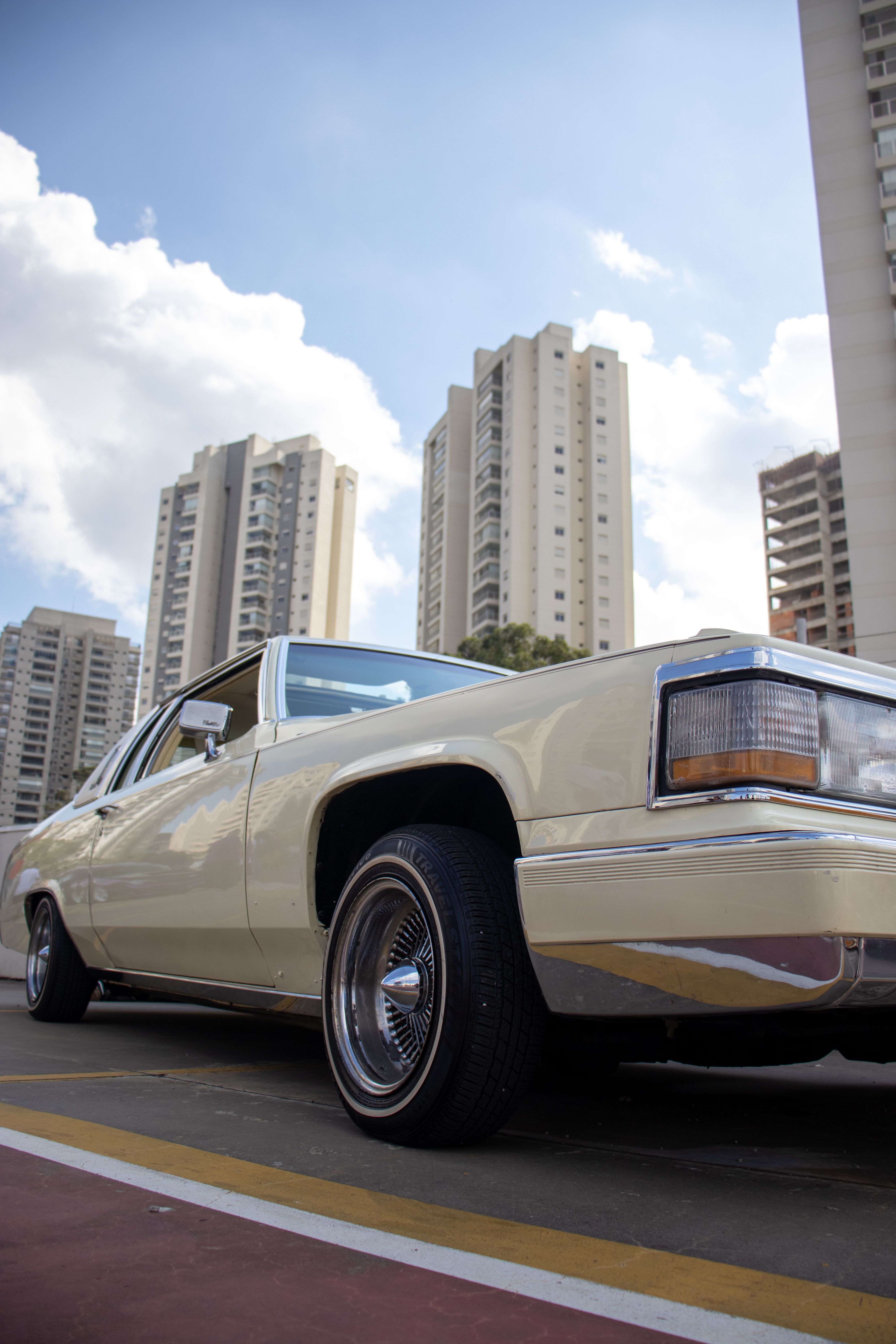 Beige Cadillac DeVille Driving on Street · Free Stock Photo