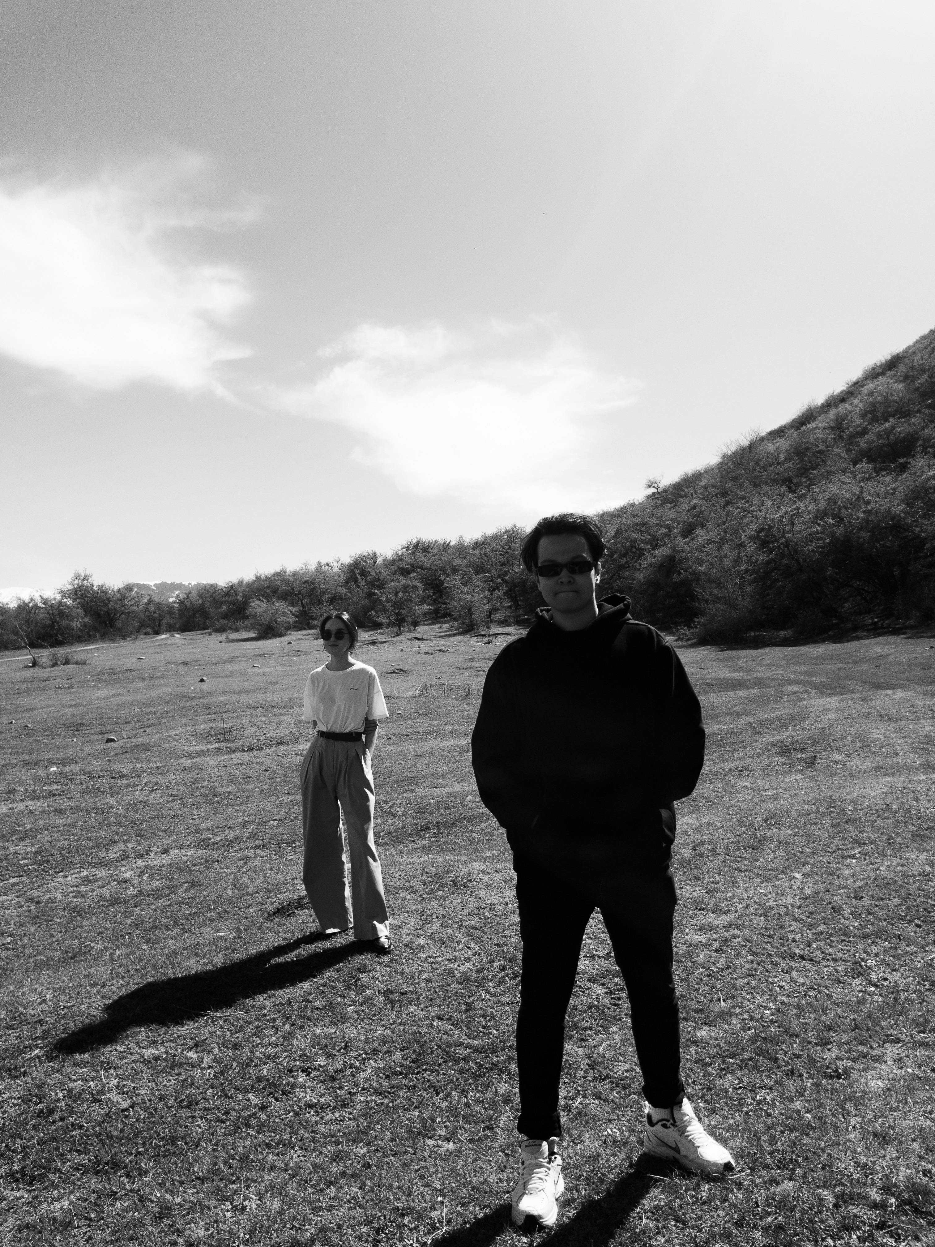 Woman and Men Posing on Field · Free Stock Photo