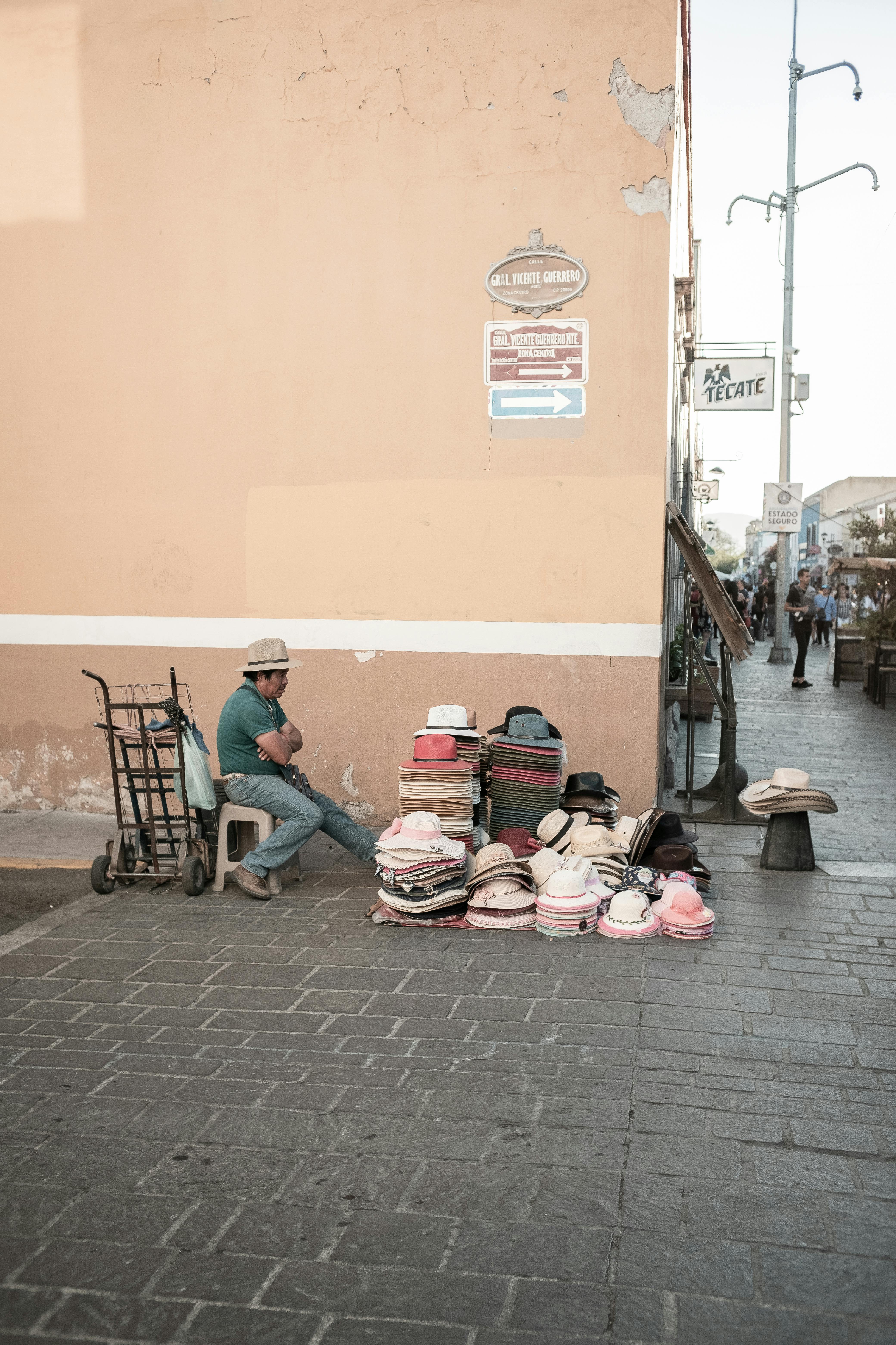 Man Selling Hats on a Street · Free Stock Photo