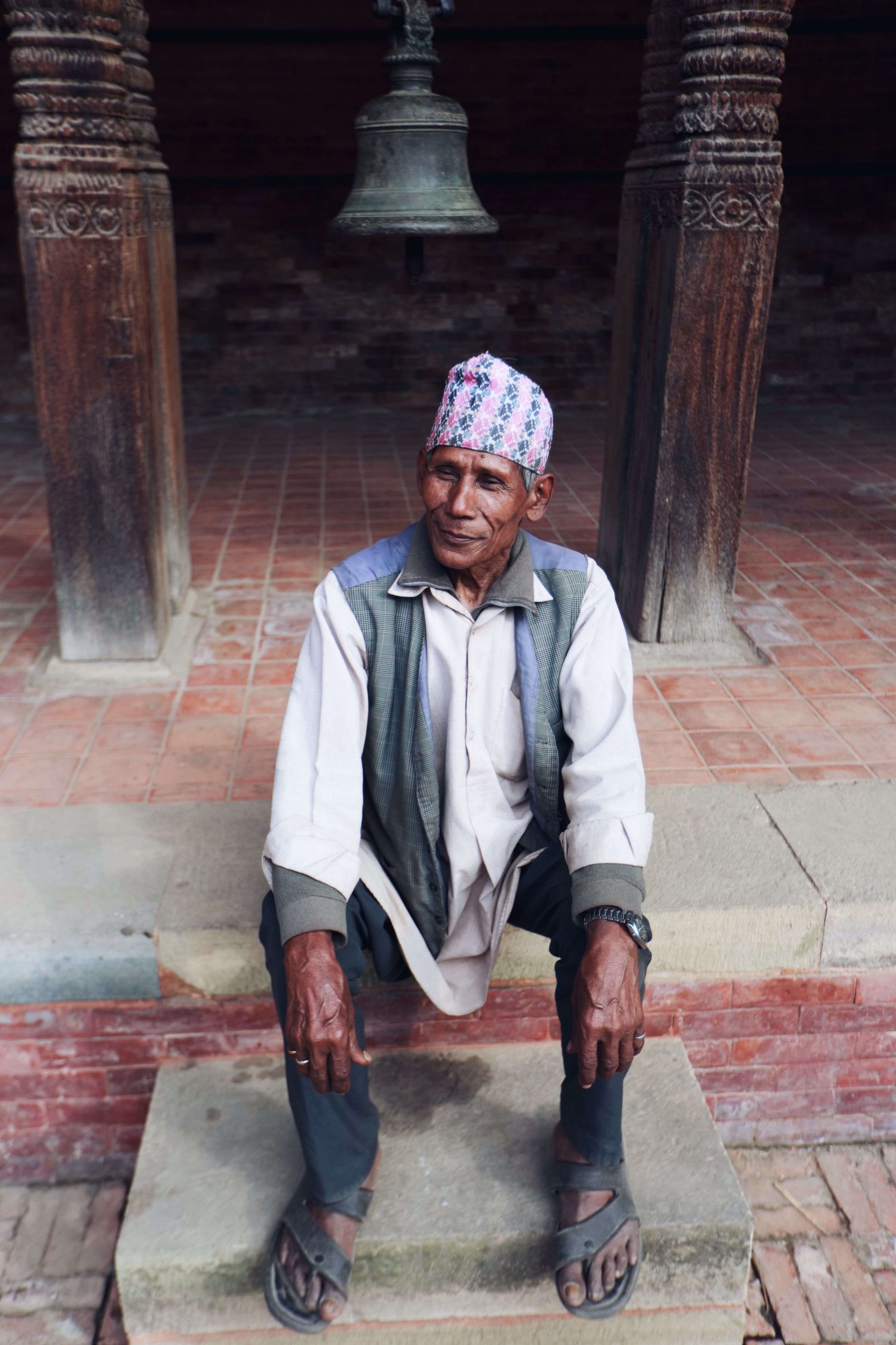 A Man Sitting in front of a Temple · Free Stock Photo
