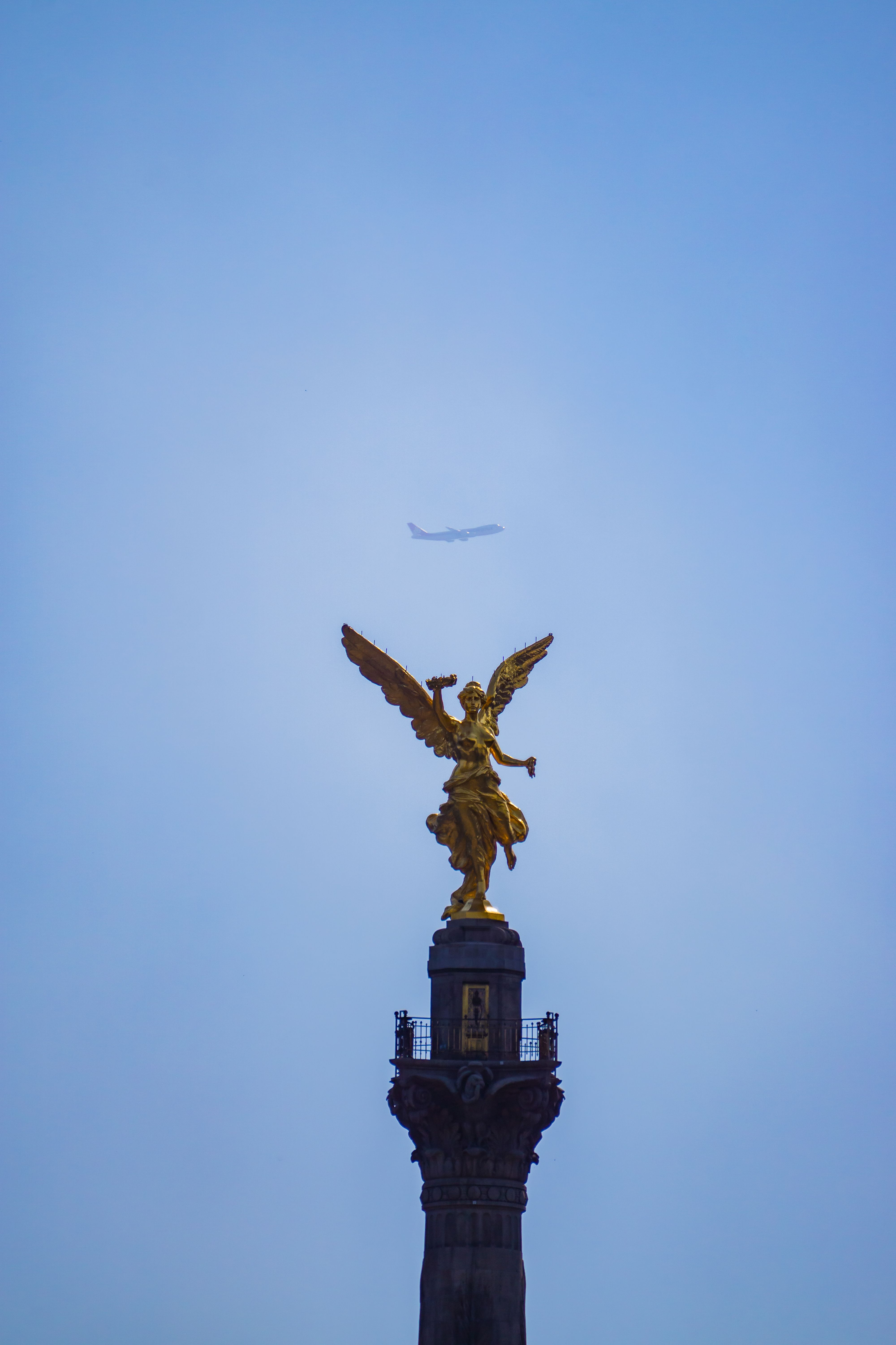 Airplane Flying over the Angel of Independence · Free Stock Photo