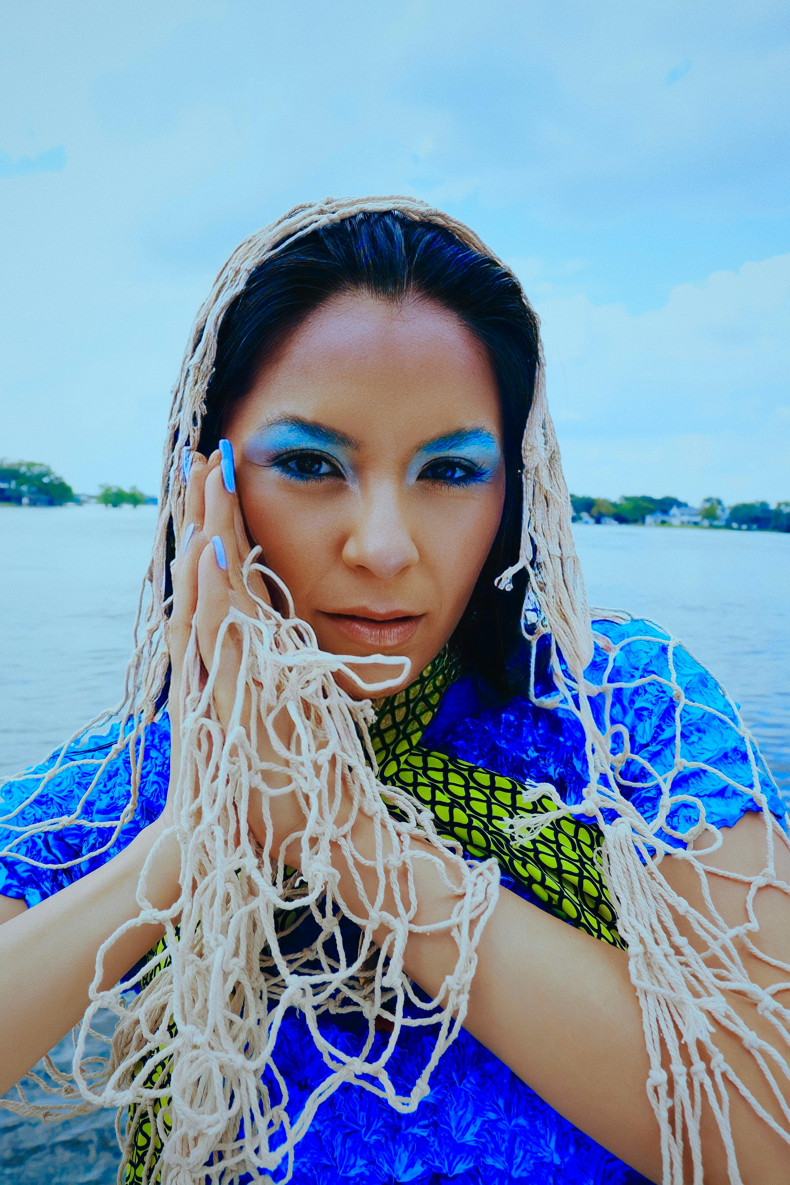 Young Woman in Blue Makeup Wearing a Fishing Net over Her Head · Free ...