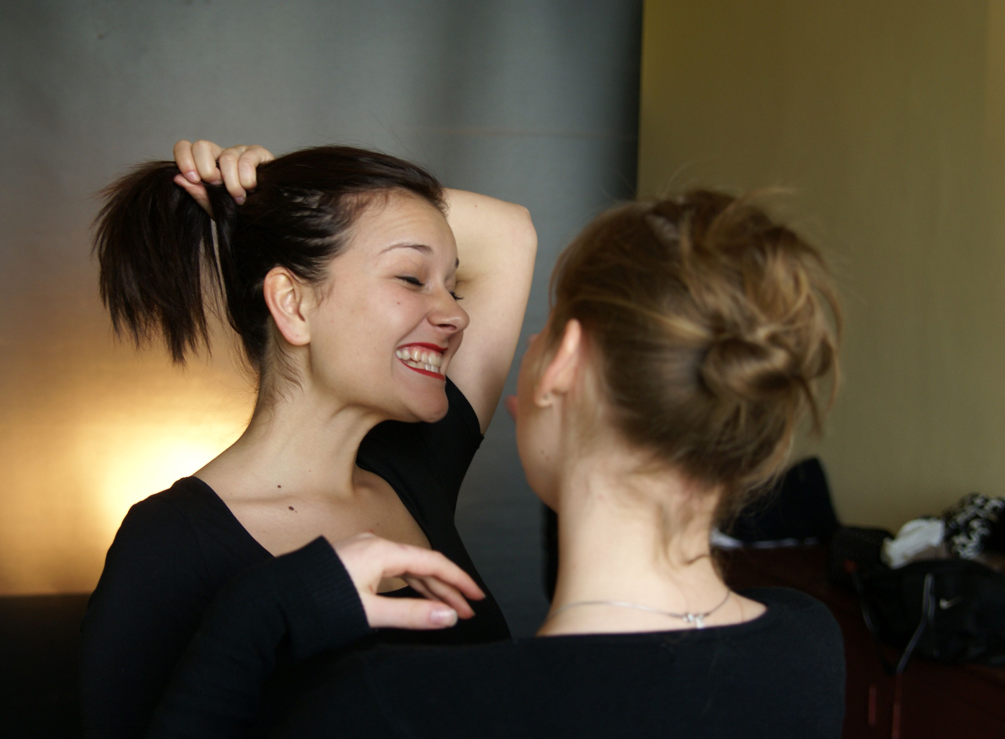 Two women in black shirts are smiling at each other · Free Stock Photo